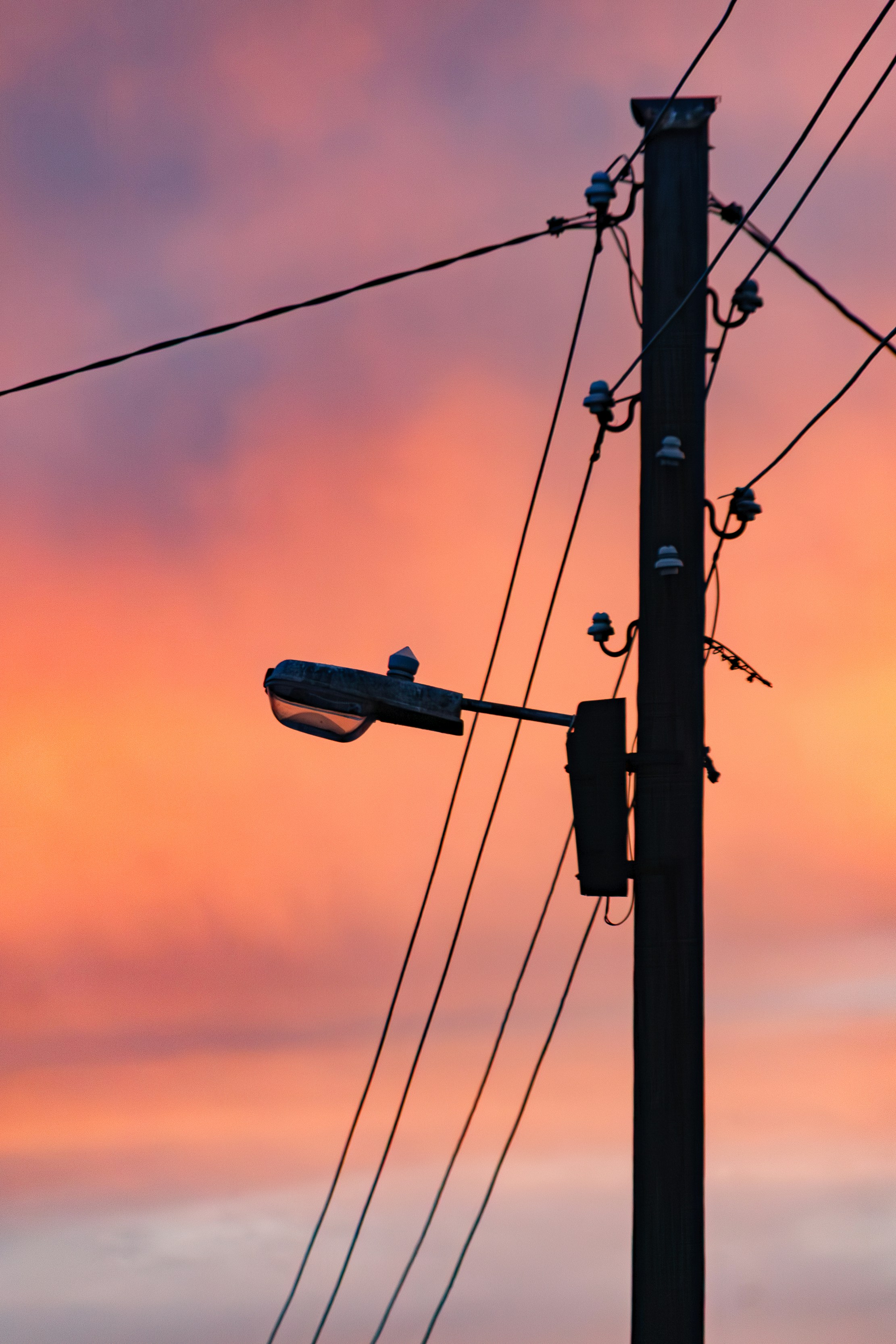 Pole and Wires at Dusk: Neon Sky in Silence