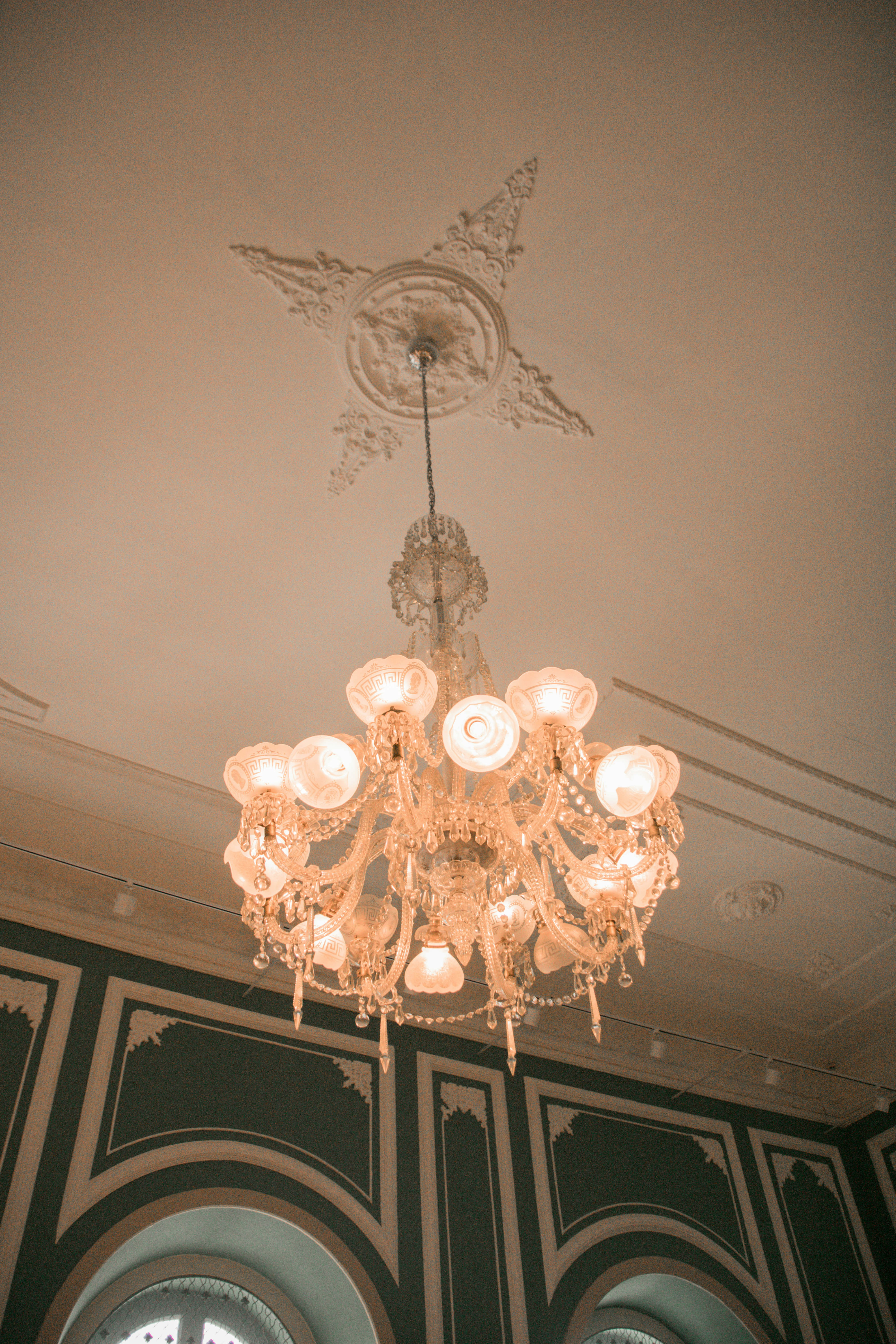 Ornate Crystal Chandelier Suspended Under an Elaborate Plaster Star