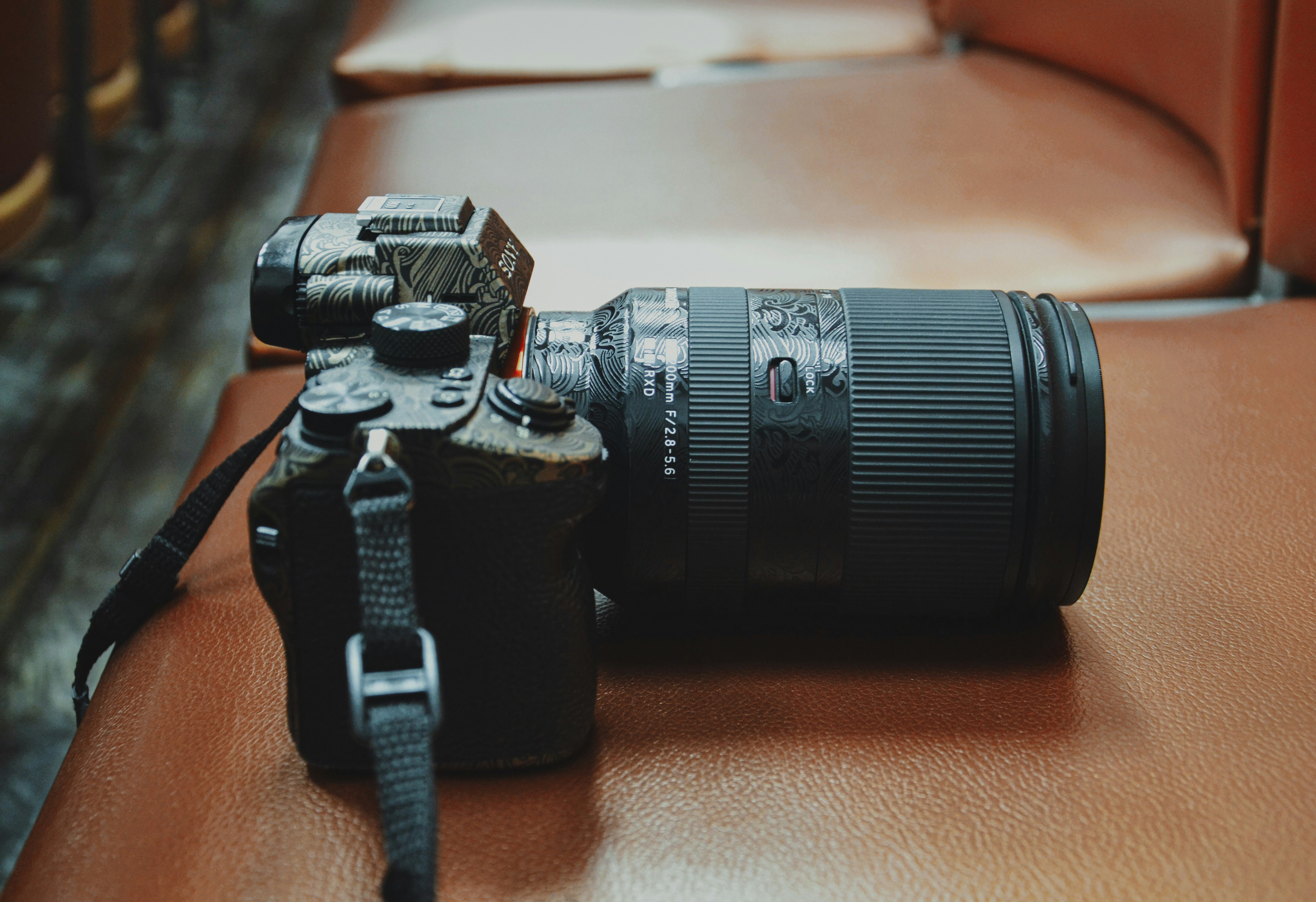 Carbon Fiber Vision: A Canonical DSLR Resting on Brown Leather