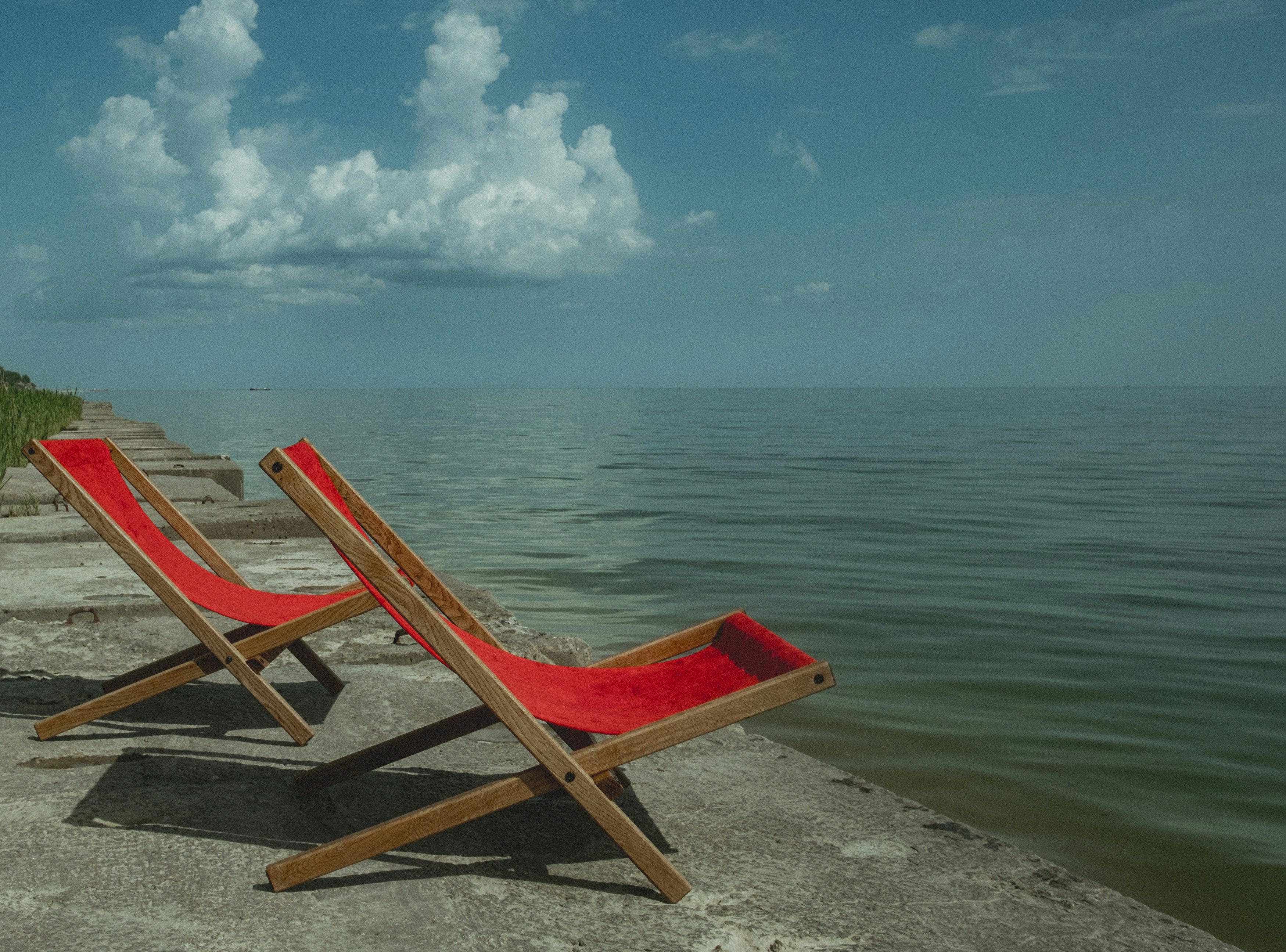 Red Deck Chairs by the Quiet Sea