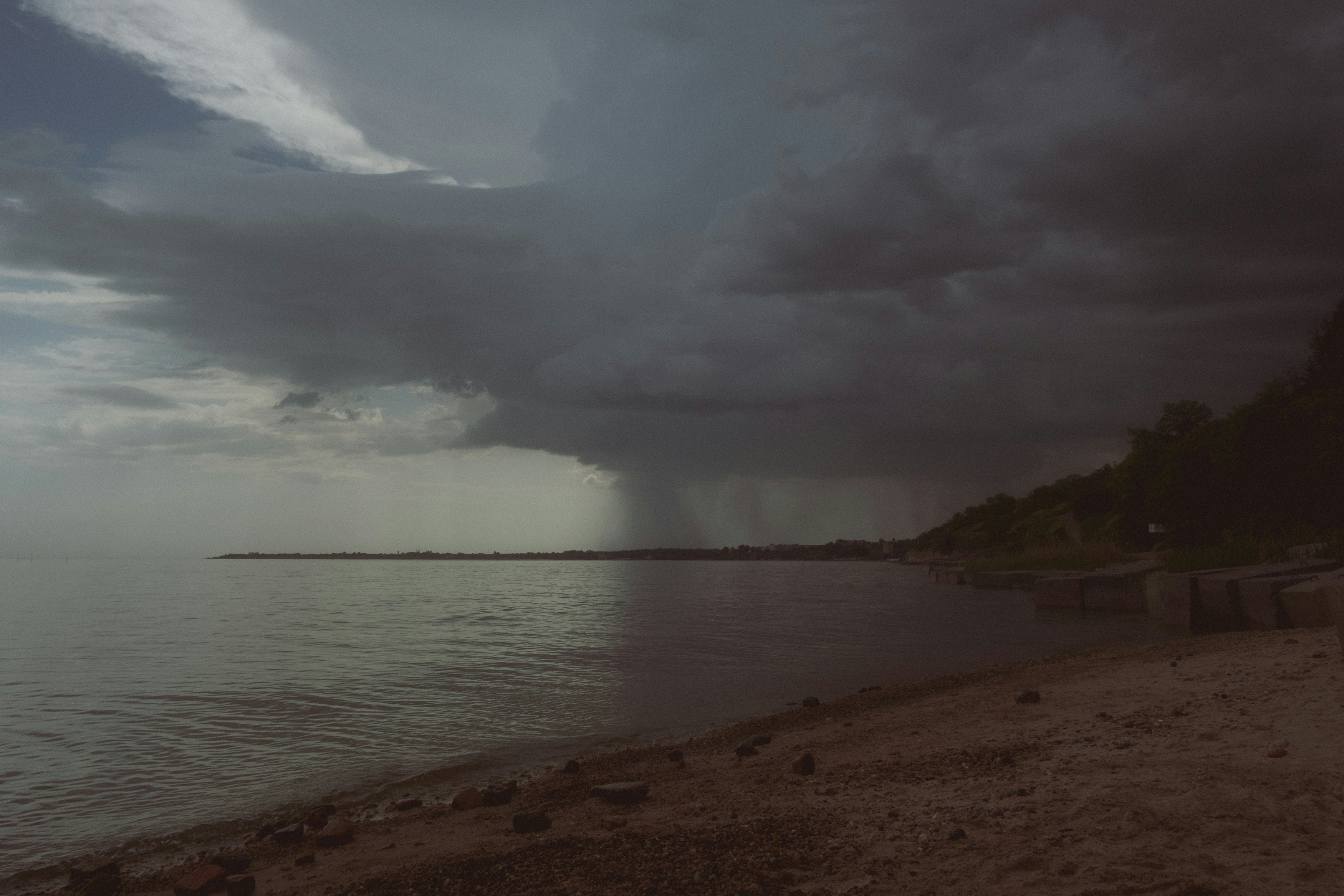 Storm approaching along a quiet shoreline