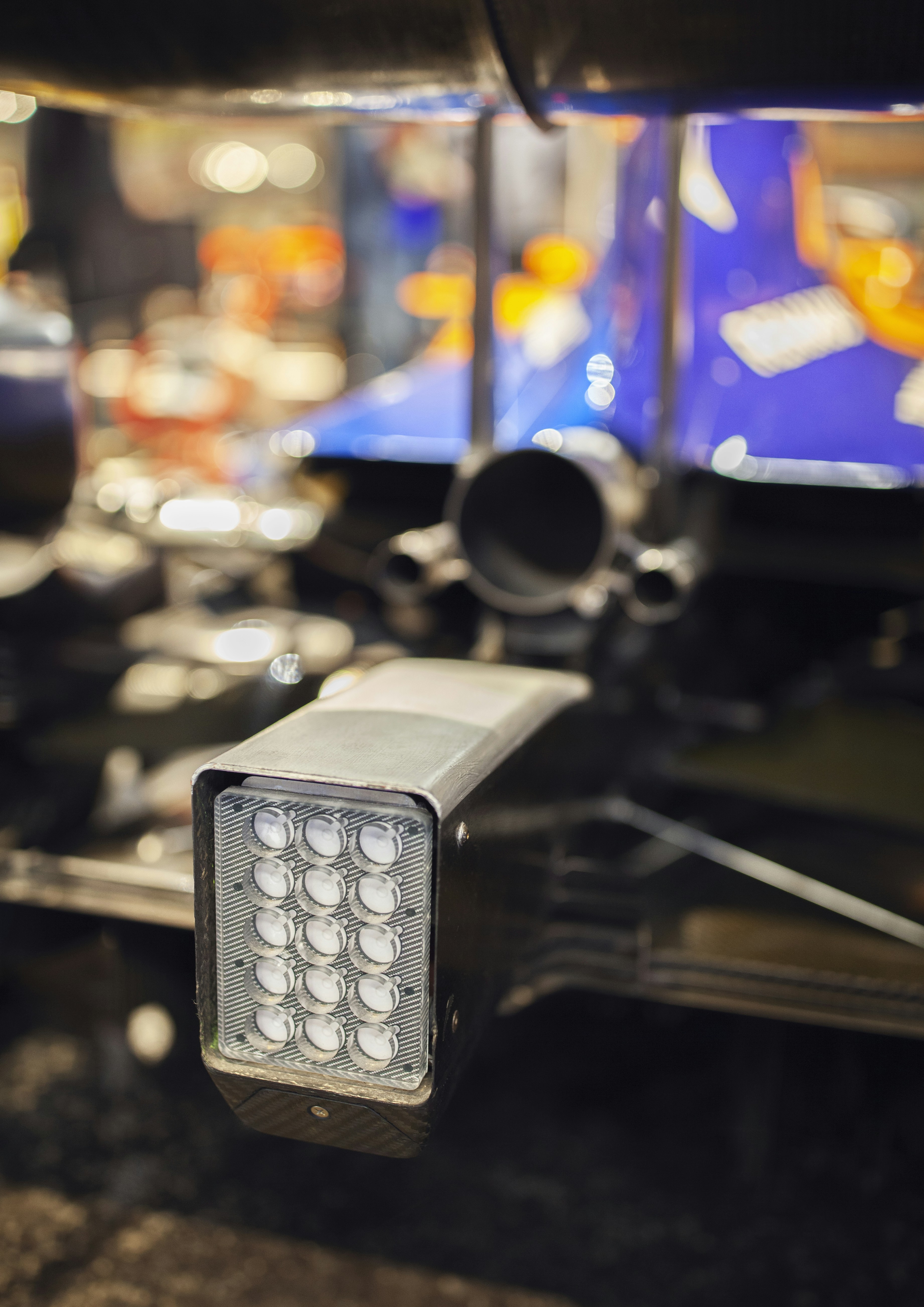 LED Worklight on a Busy Vehicle Frame in Soft Bokeh