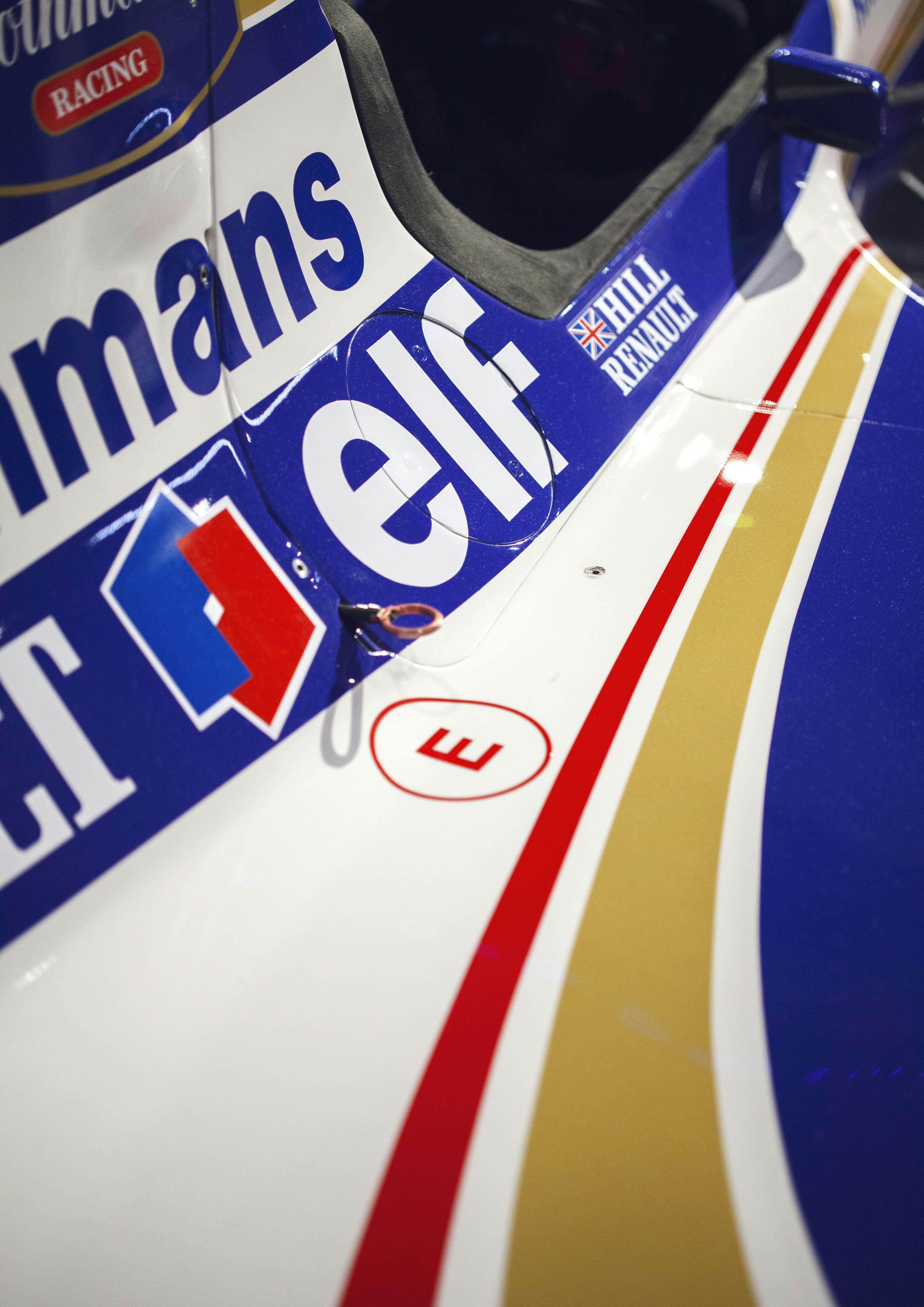 Blue race car skin with bold Элf and sponsor markings at sunlit curve