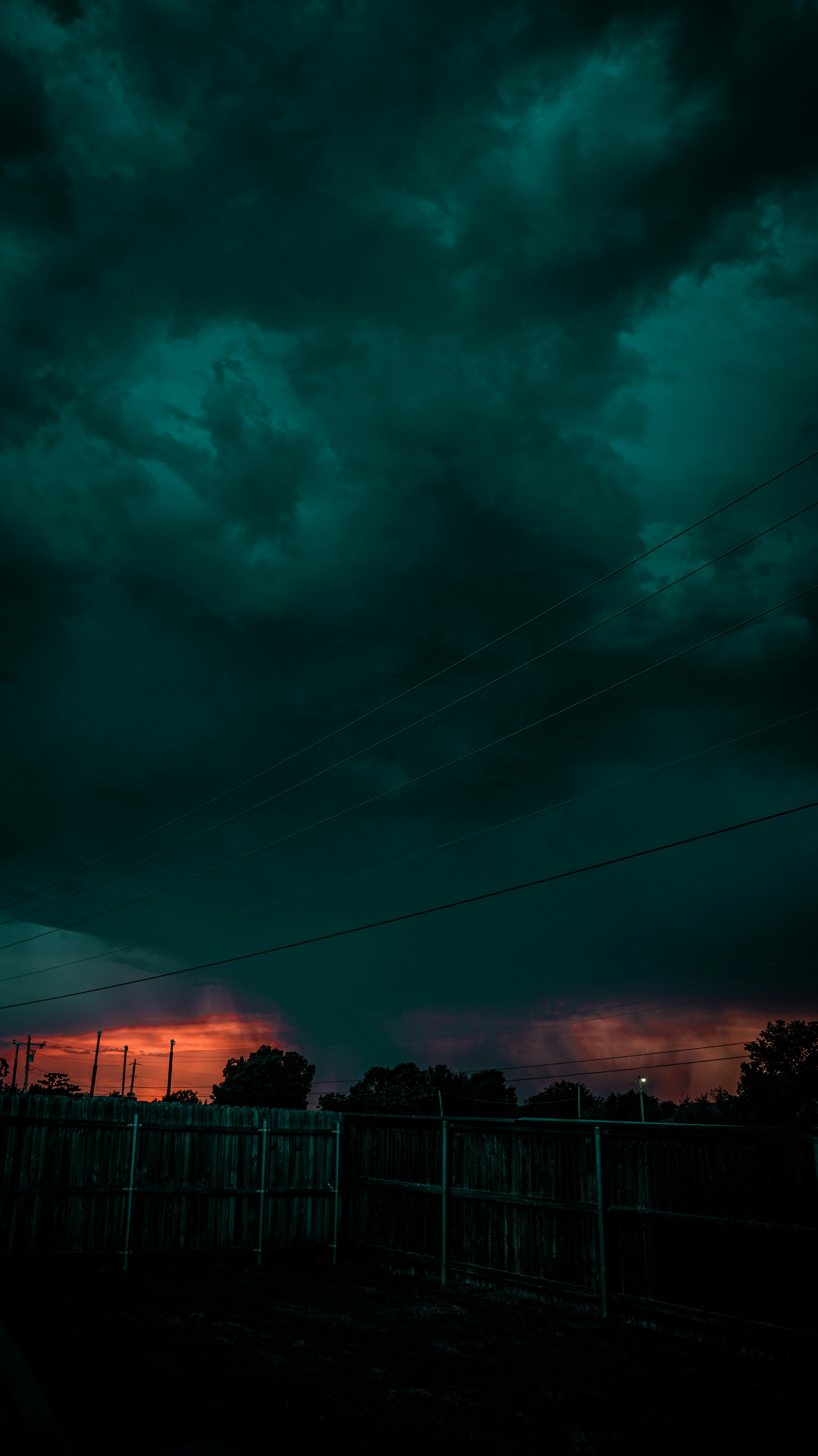 Storm Seam: Twin Vines of Color Over a Quiet Backyard