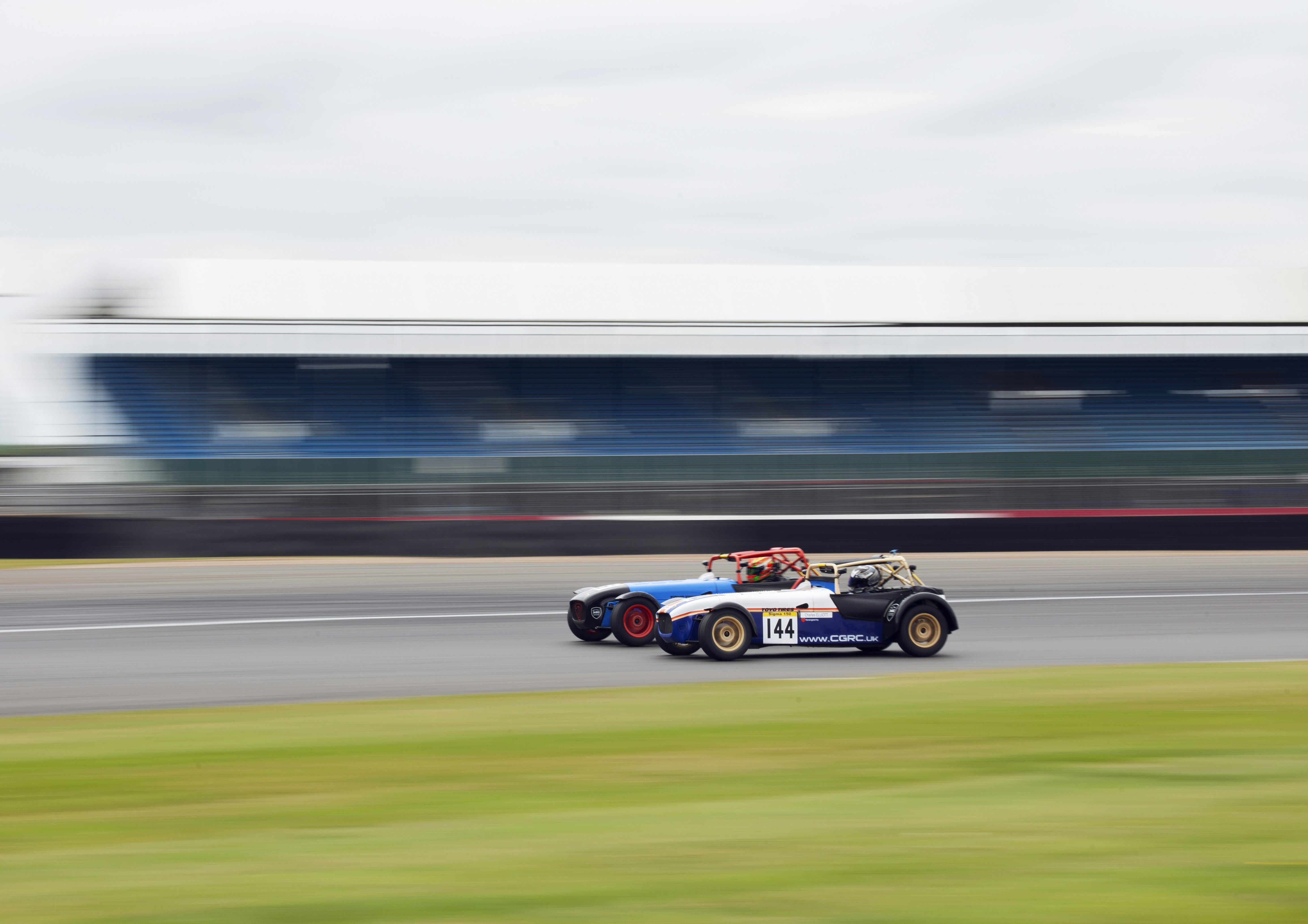 Blurred Pace: a Vintage Race Car Sparks Across the Track