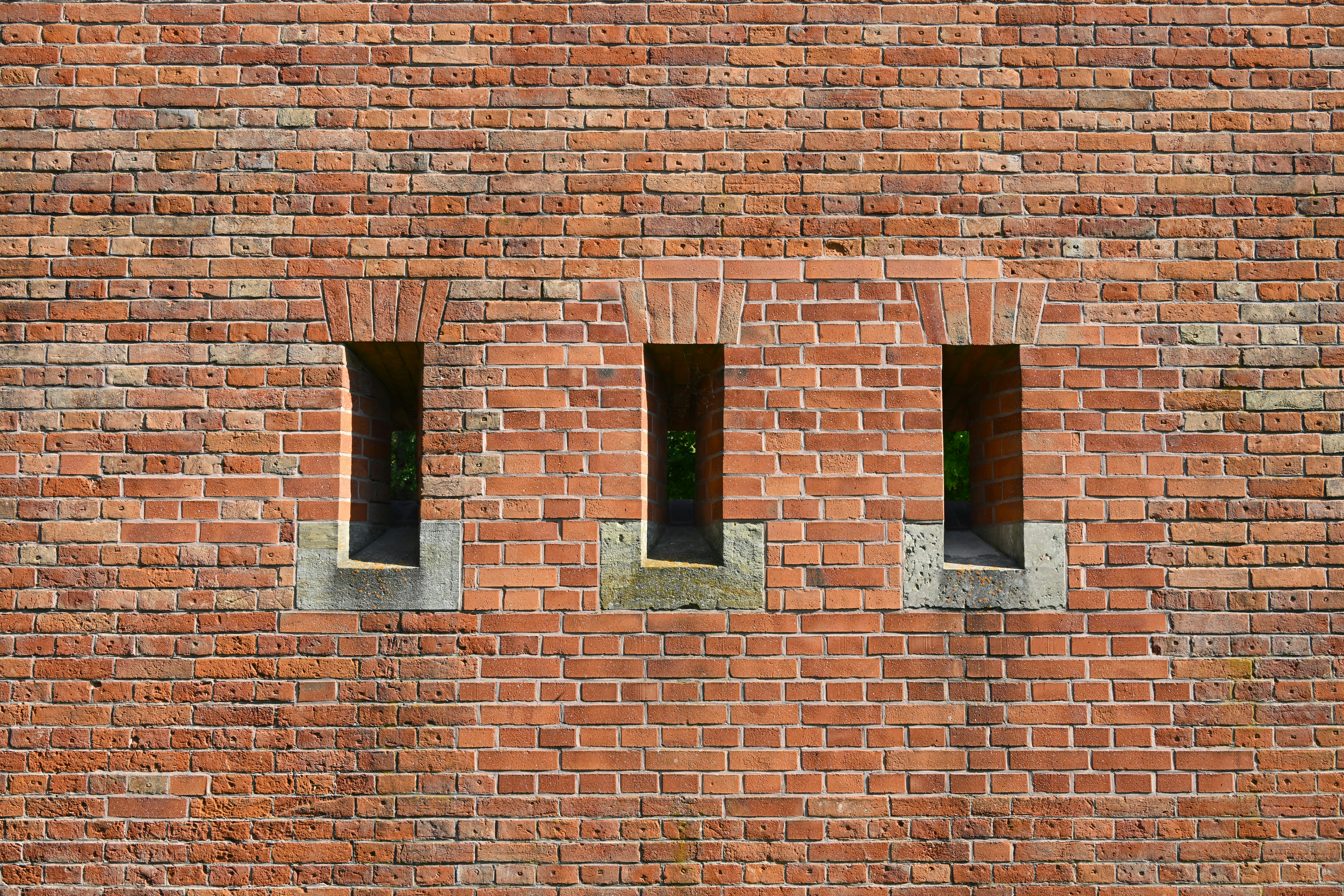 Three Narrow Windows in Repeating Brickwork