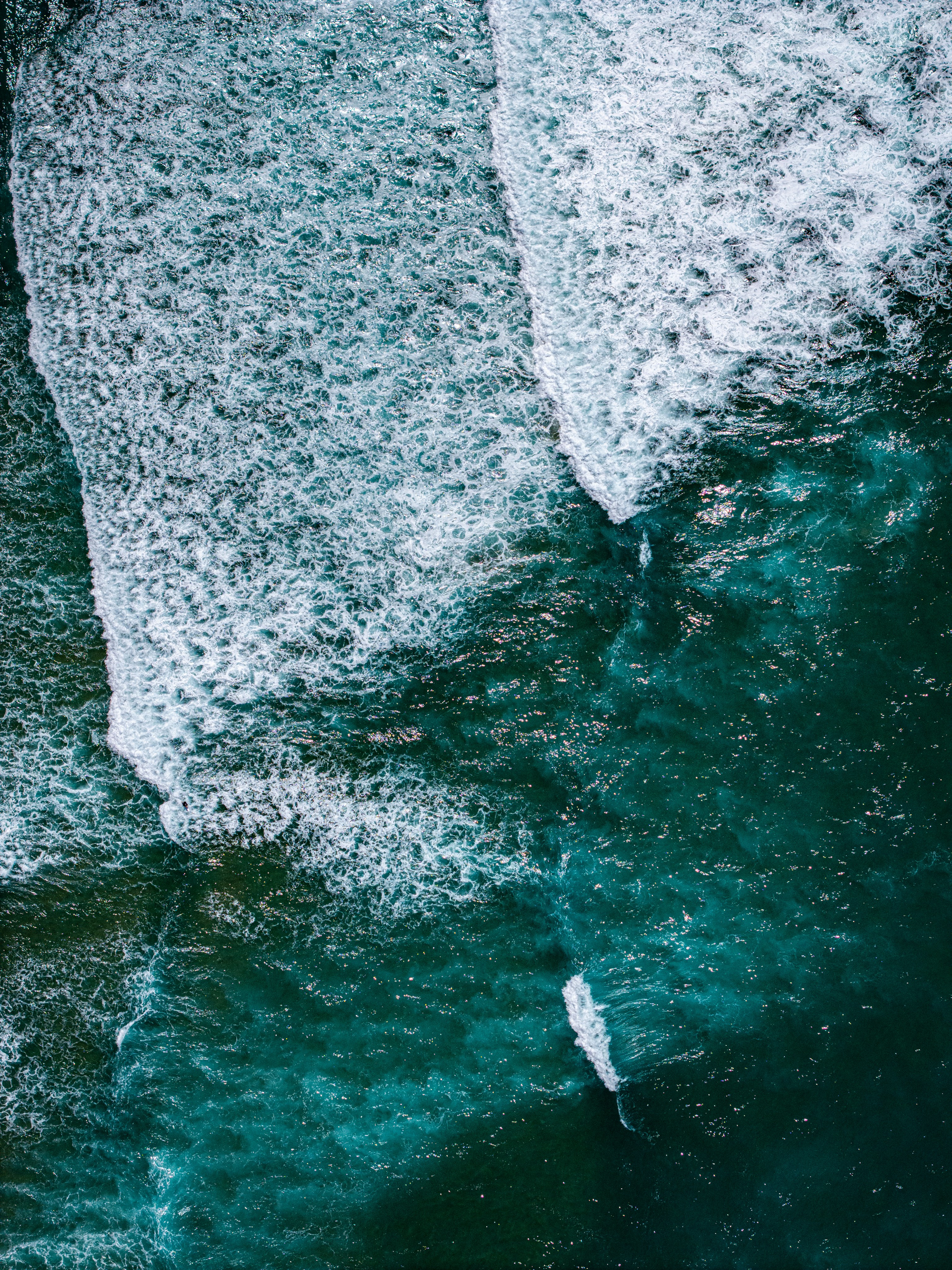 Coastal Break: Aerial View of Turbulent Turquoise Swell Colliding with Foam
