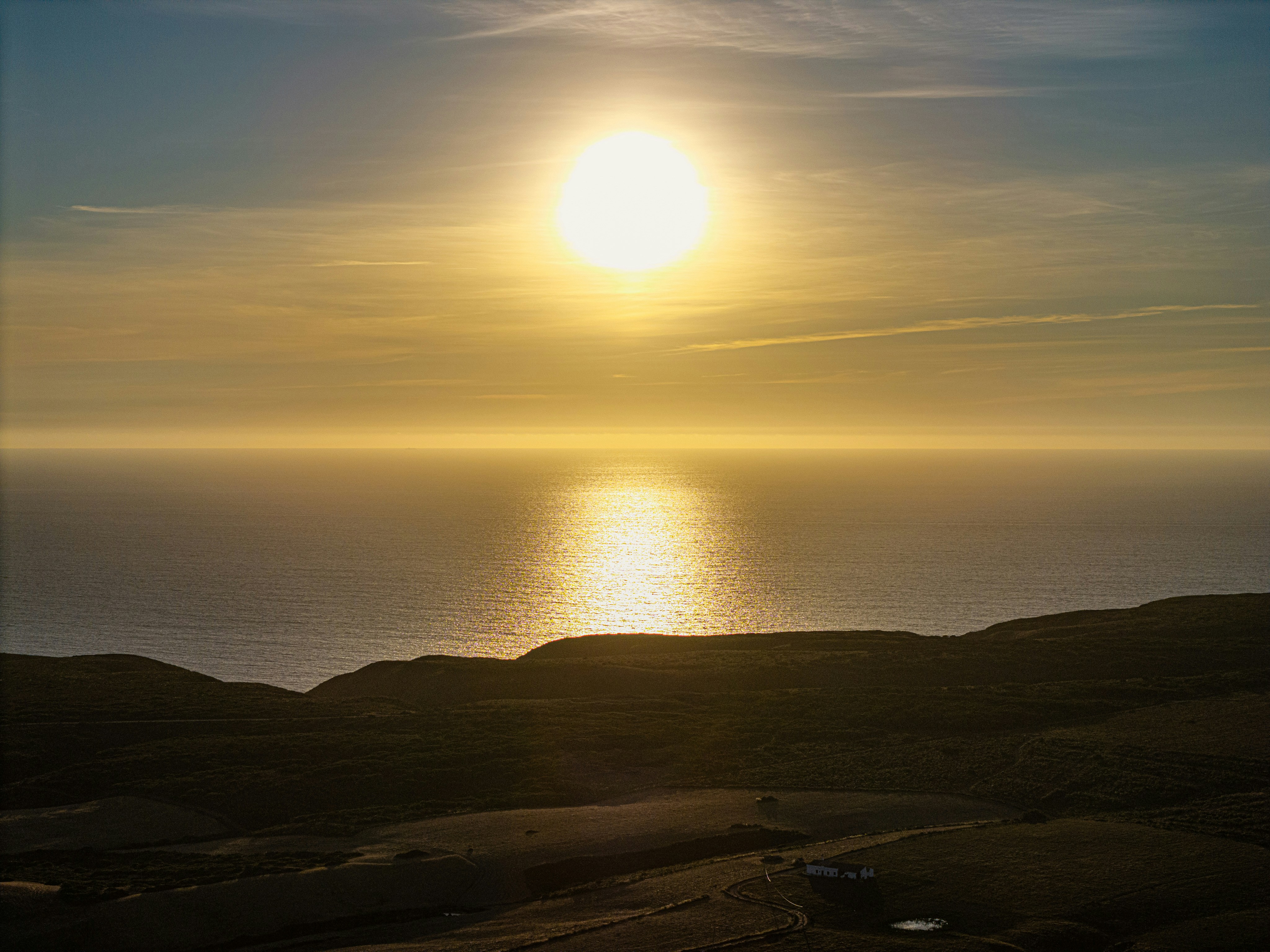 Sunlit Horizon: Golden Calm Over Coastal Cliffs