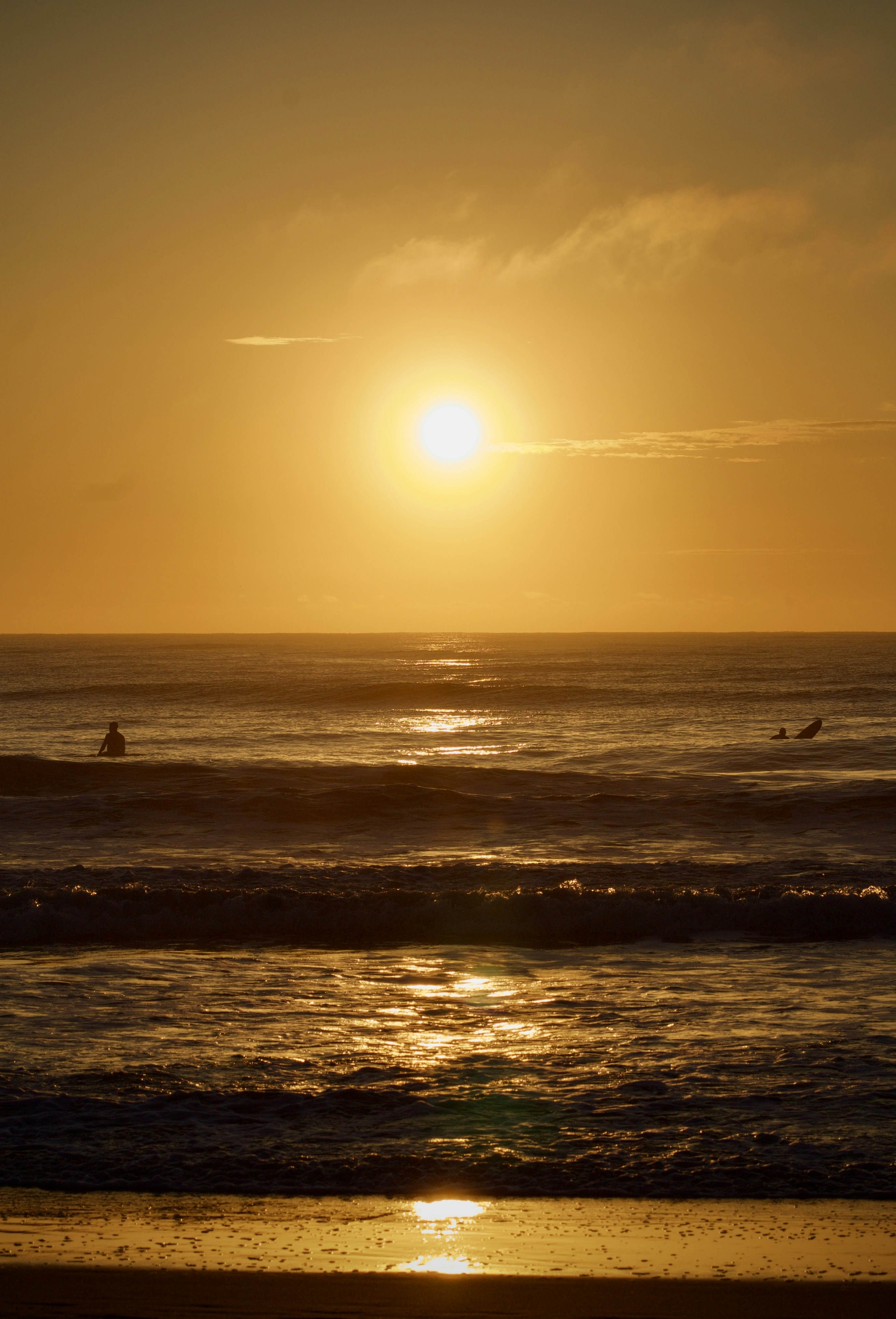 Golden Horizon: A Quiet Sunset Over Wind-Softened Waves