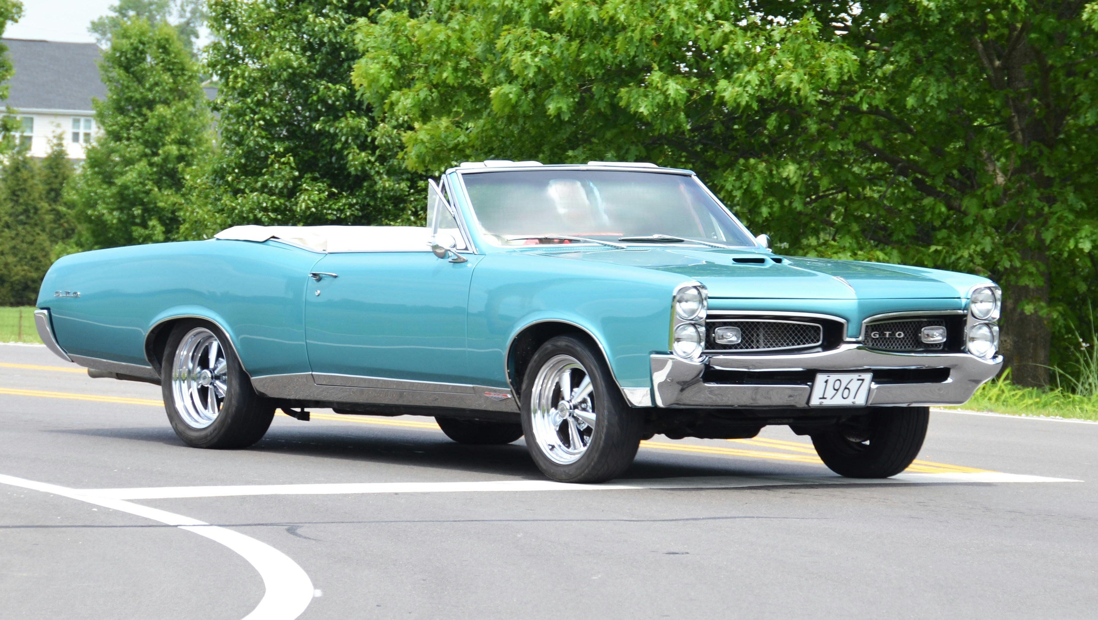 Turquoise 1967 Ford Convertible: Sunset-Blue Classic in Motion