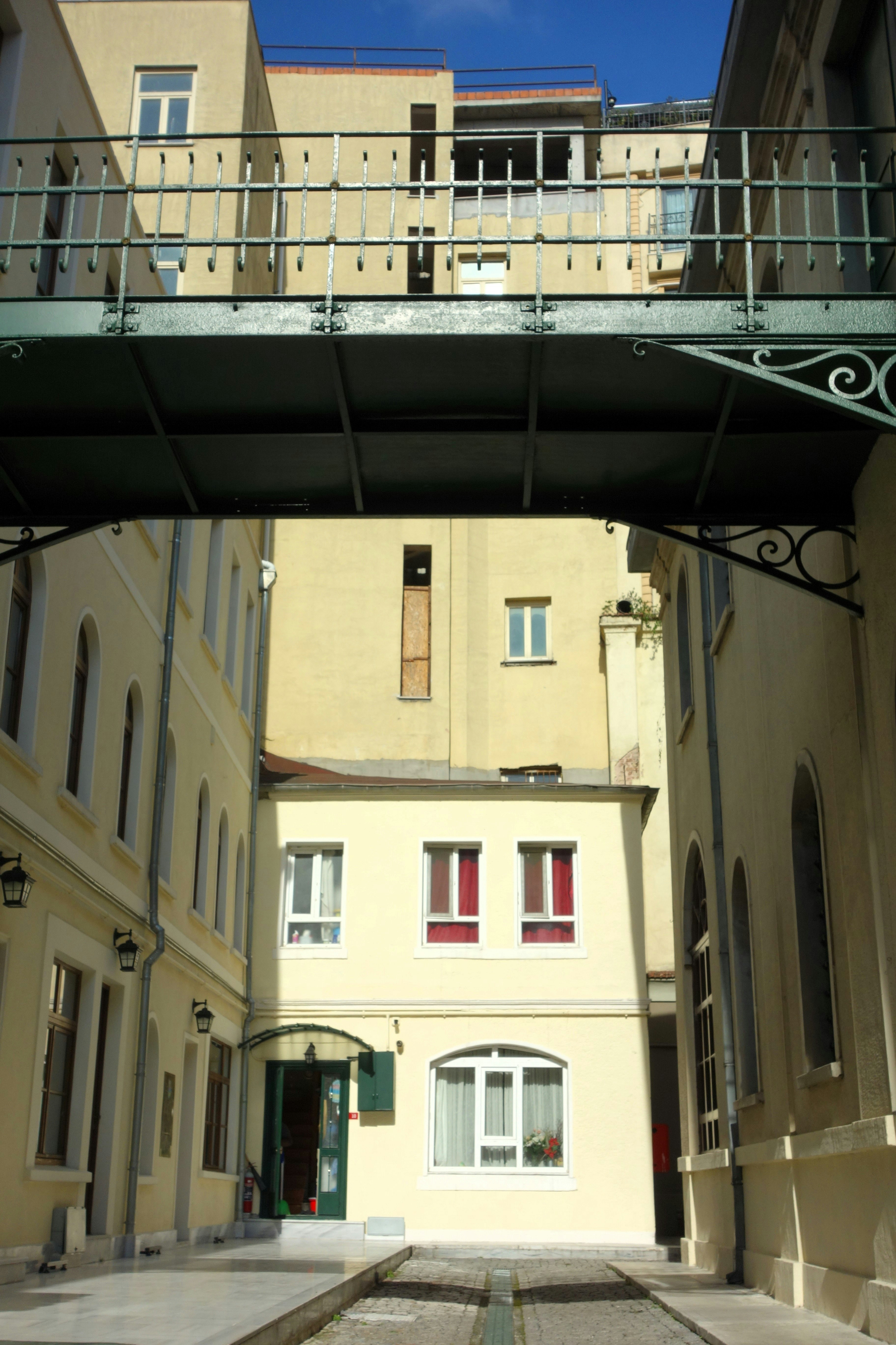 Sunlit Courtyard Gateways: A Symmetry of Yellow Facades
