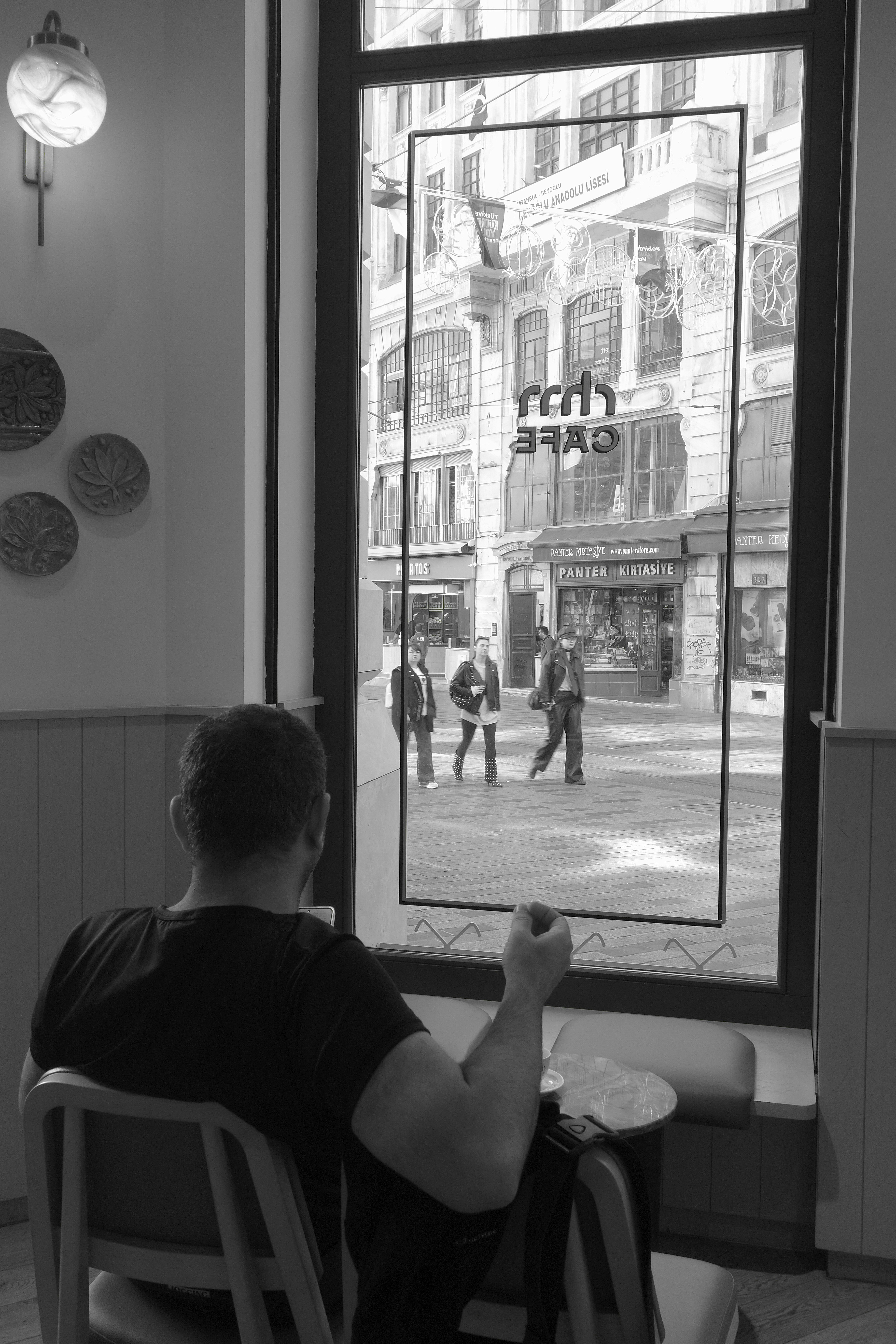 Cafe Window: City Scene Framed by a Waiting Patron