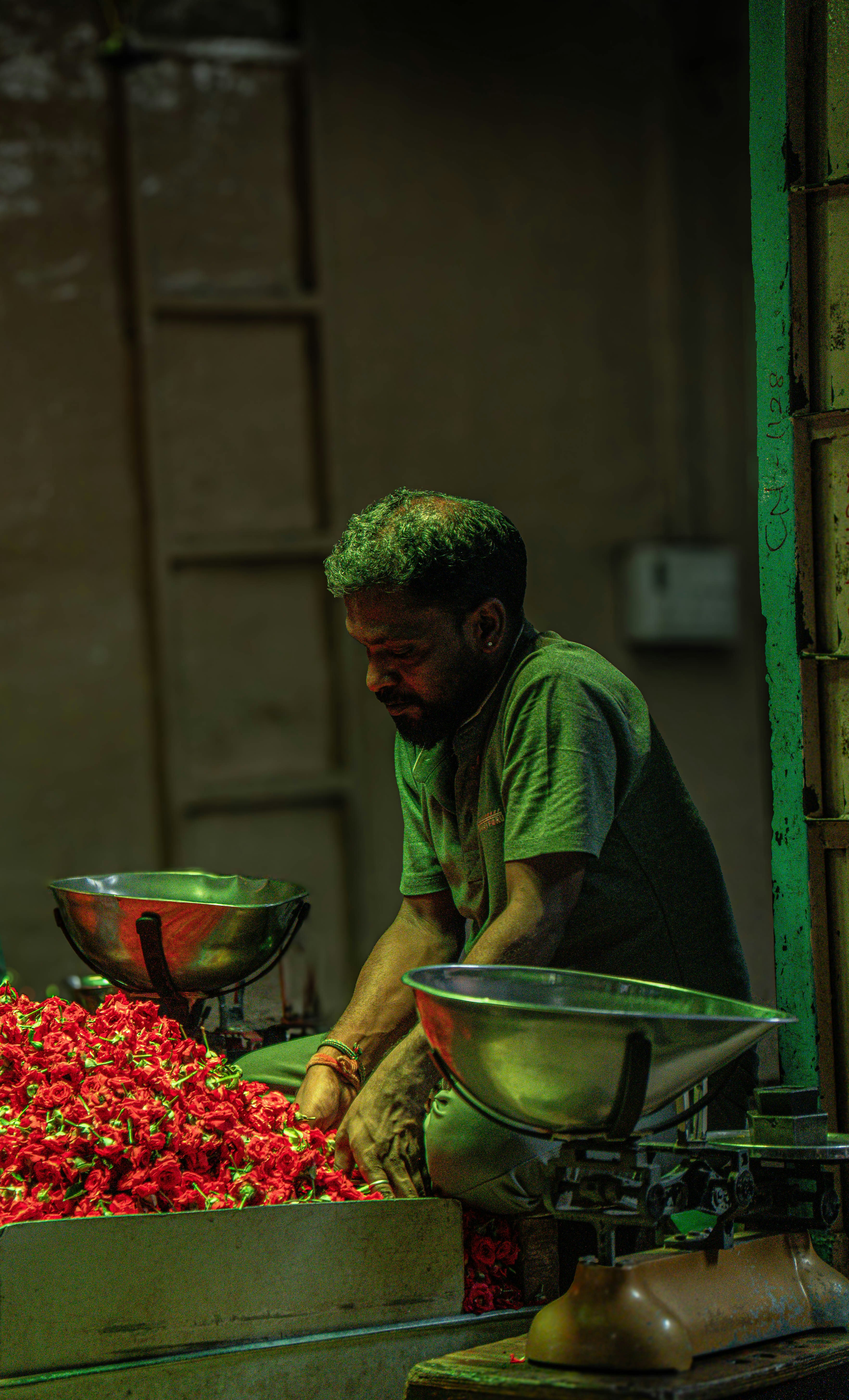 Dusk in the Spice Stall: A Man Weighs Petals and Quiet Focus