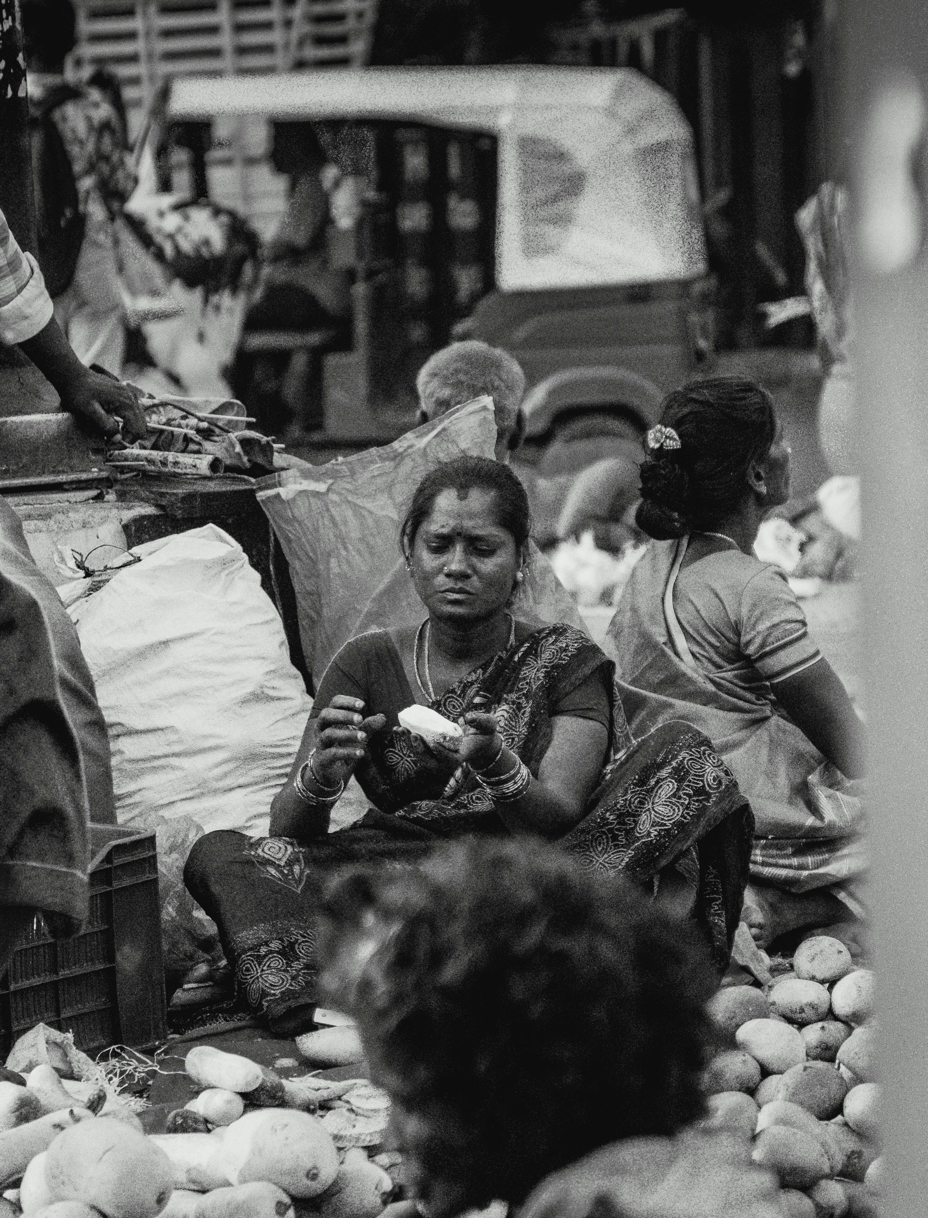 Market Moment: A Focused Portrait Amid Everyday Activity