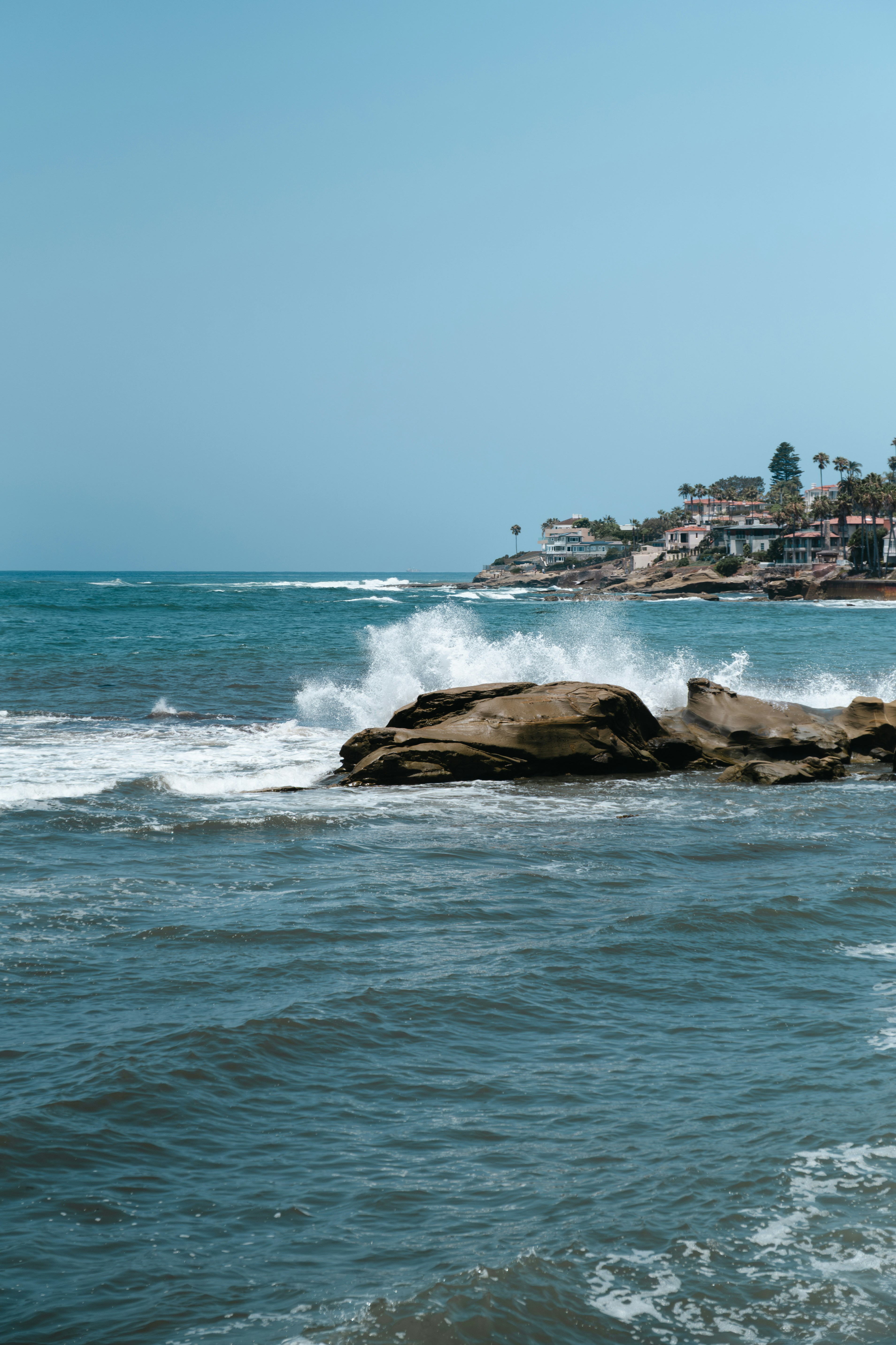 Coastal Terrace: Waves Crashing Against a Rocky Breakwater