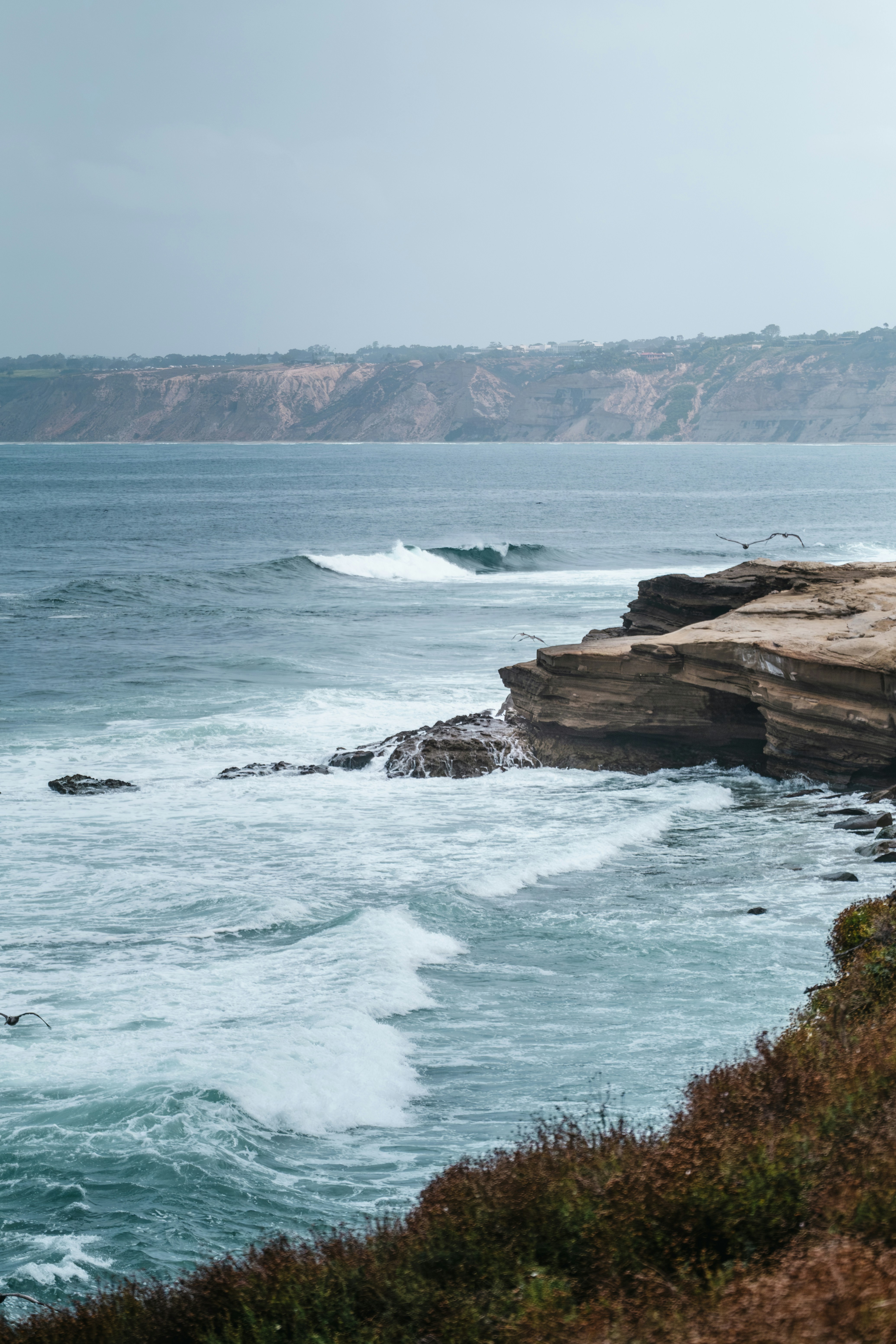 Cliffside Breakers: Ocean Spray Beneath a Quiet Horizon