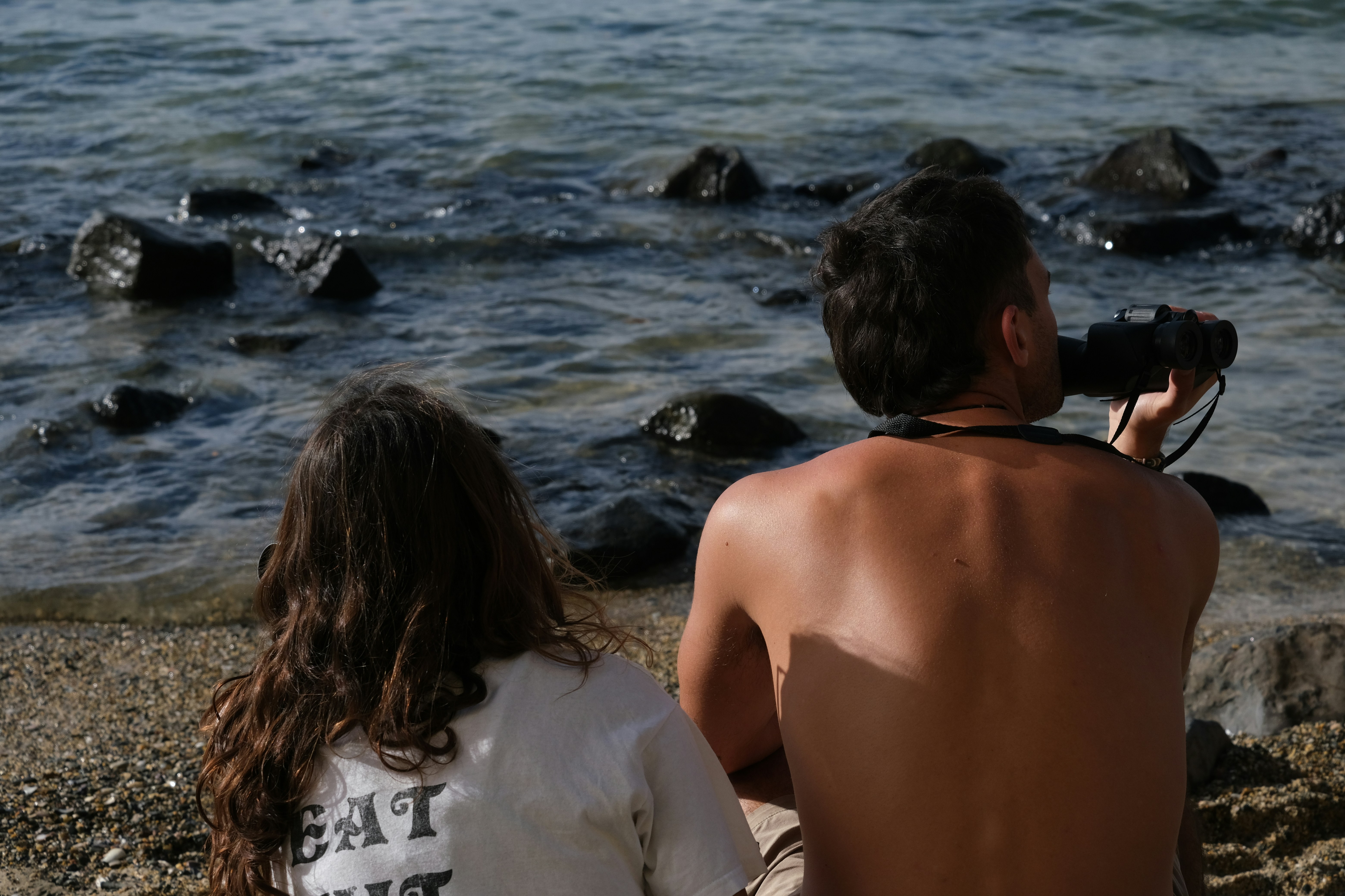 Two observers by the water: a candid moment of attention