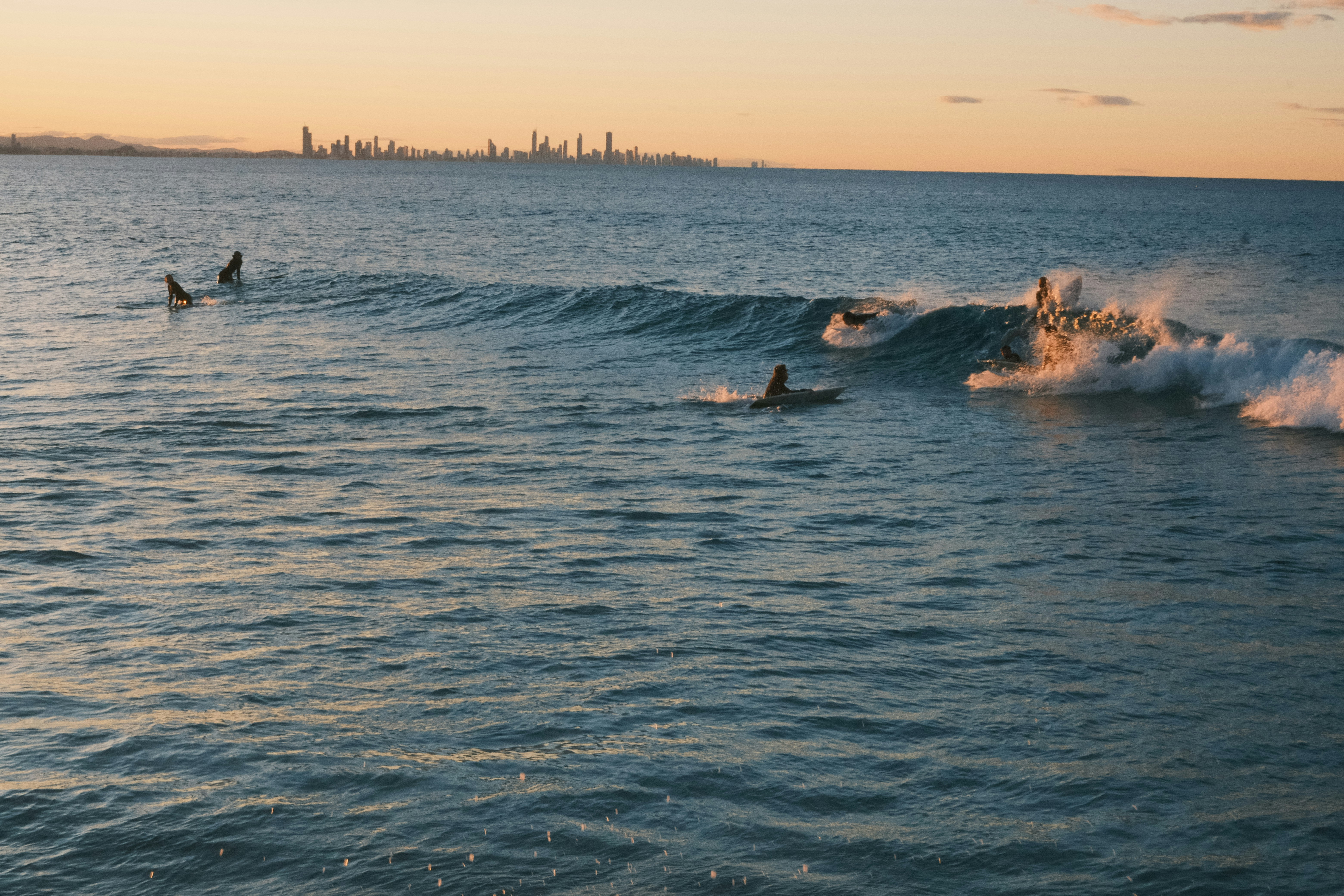 Surf Break at Sunset: Riders Cut the Quiet Horizon