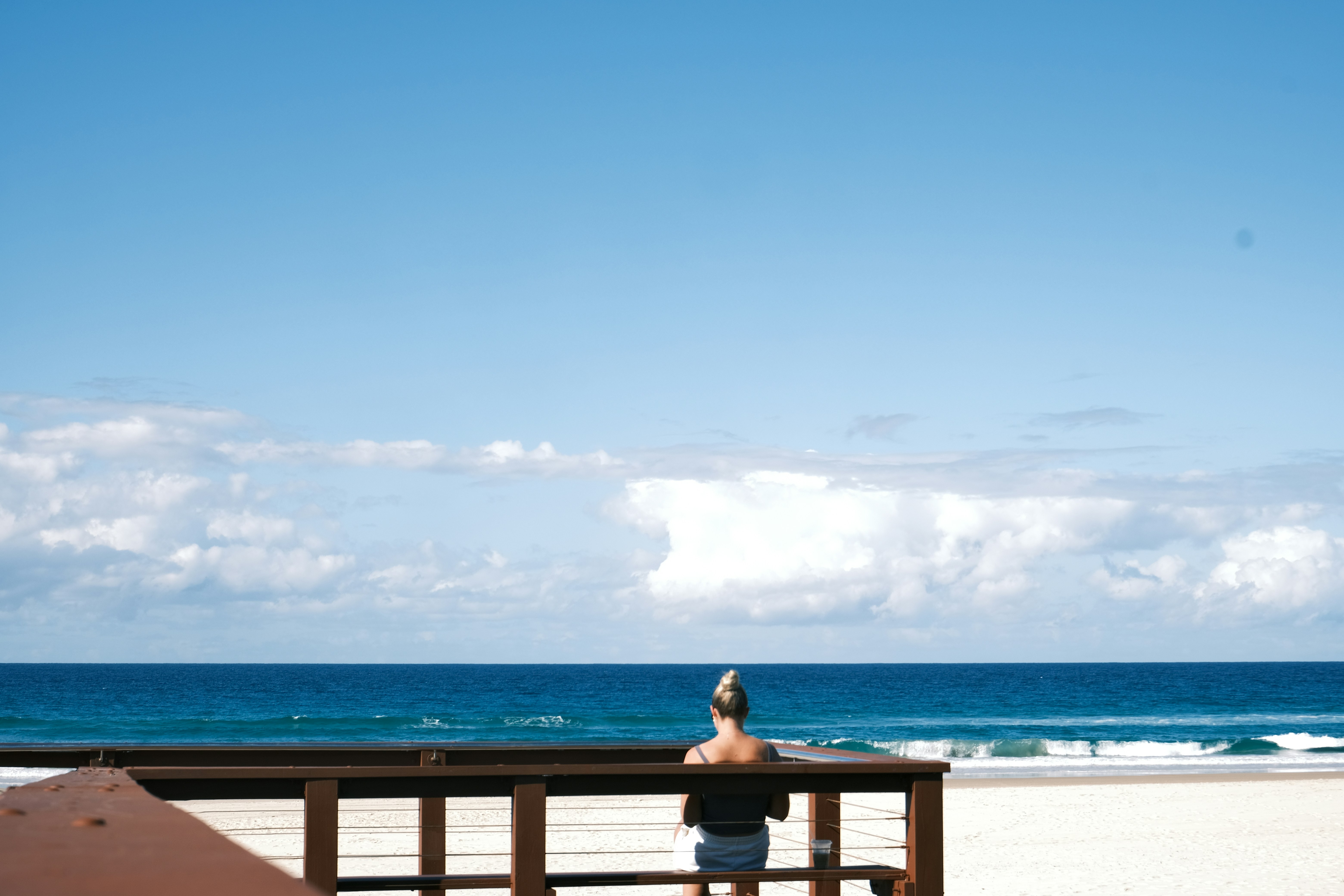 Platform of Quiet Horizon: A Beachgoer Gazing Toward the Sea
