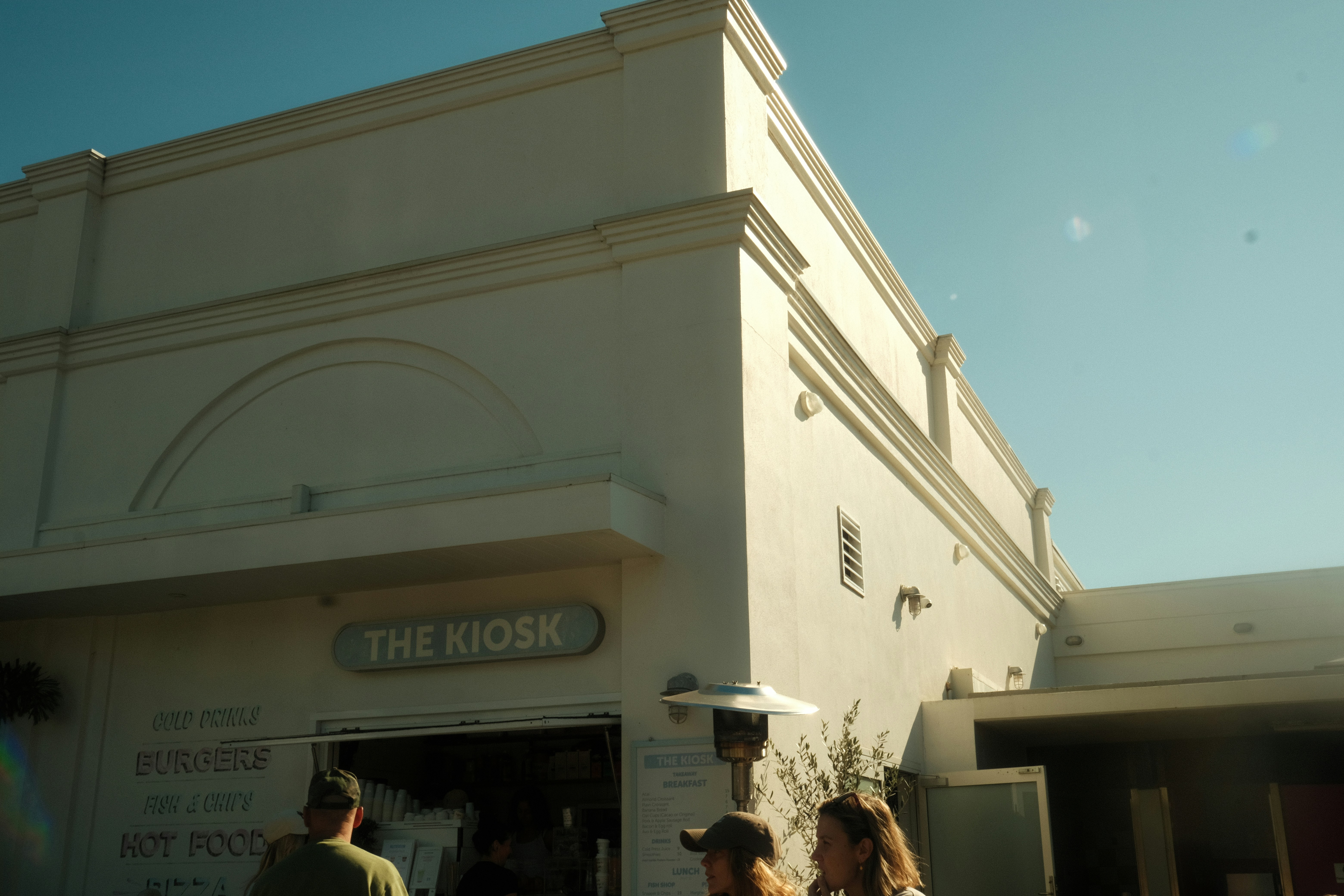 Sunlit storefront beneath a classic curved facade