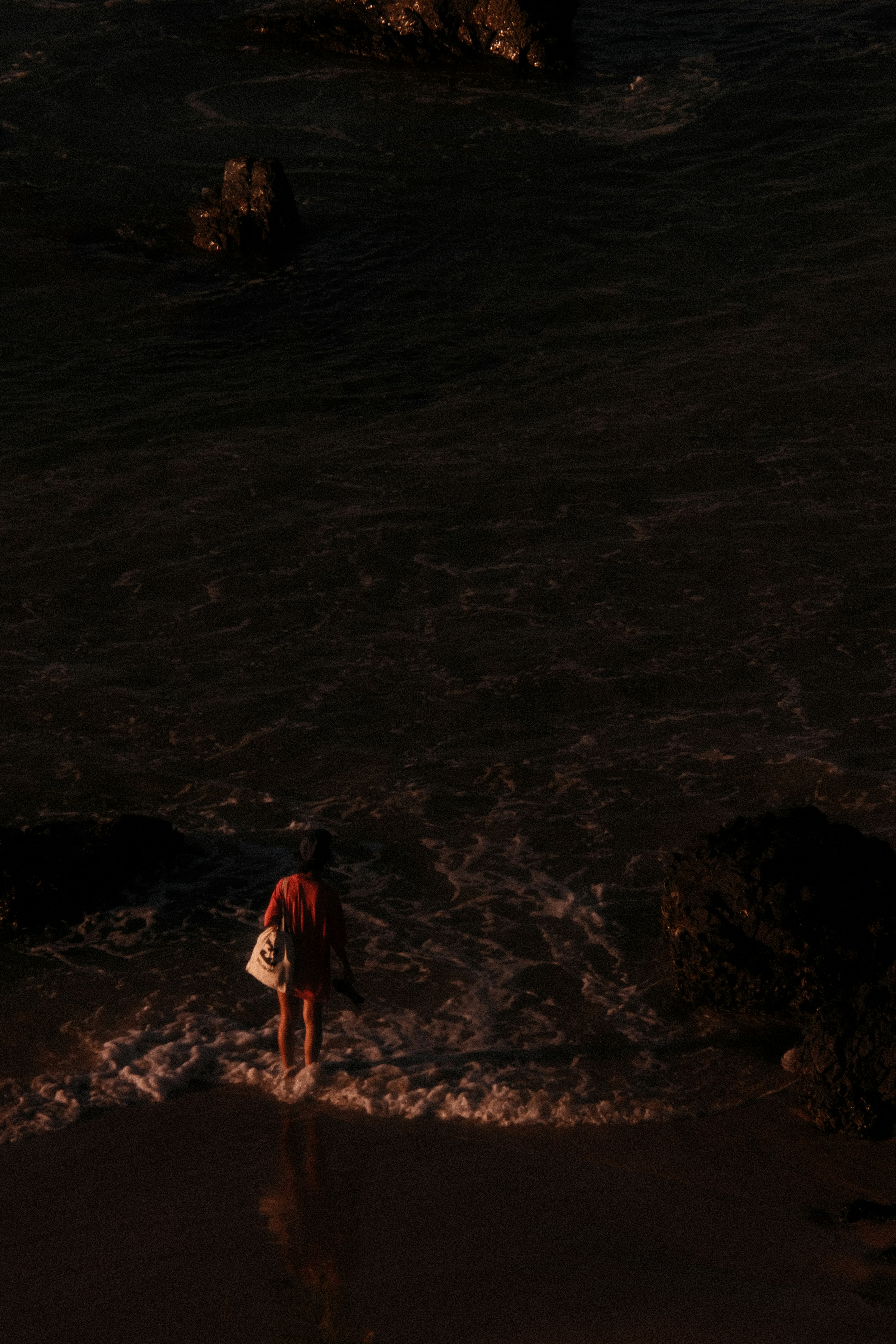 Night Sea Walk: A lone figure at the shore under dim dusk hues