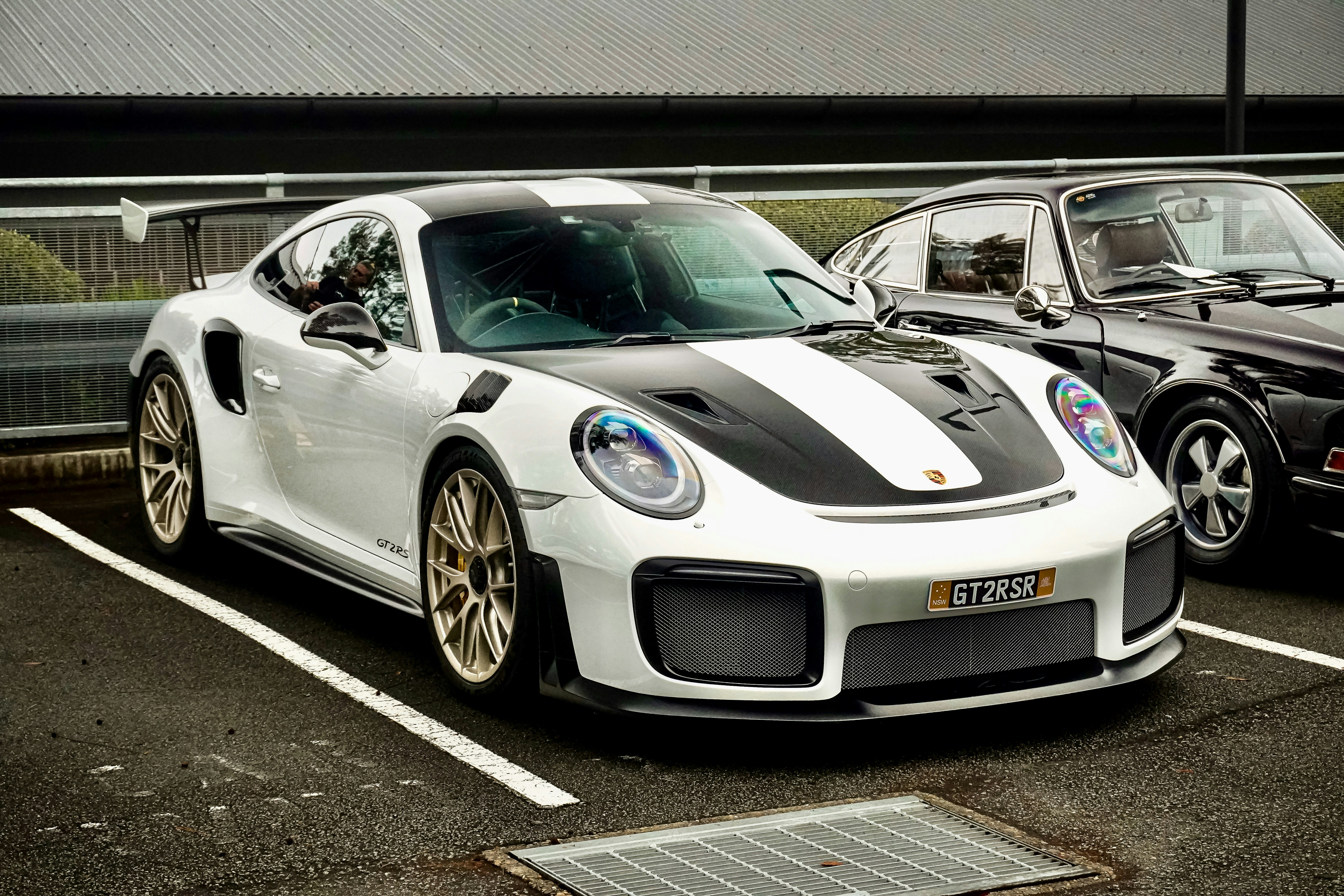 White Porsche GT3 in a Parking Lot: Bold Black Accents and Striking Stance