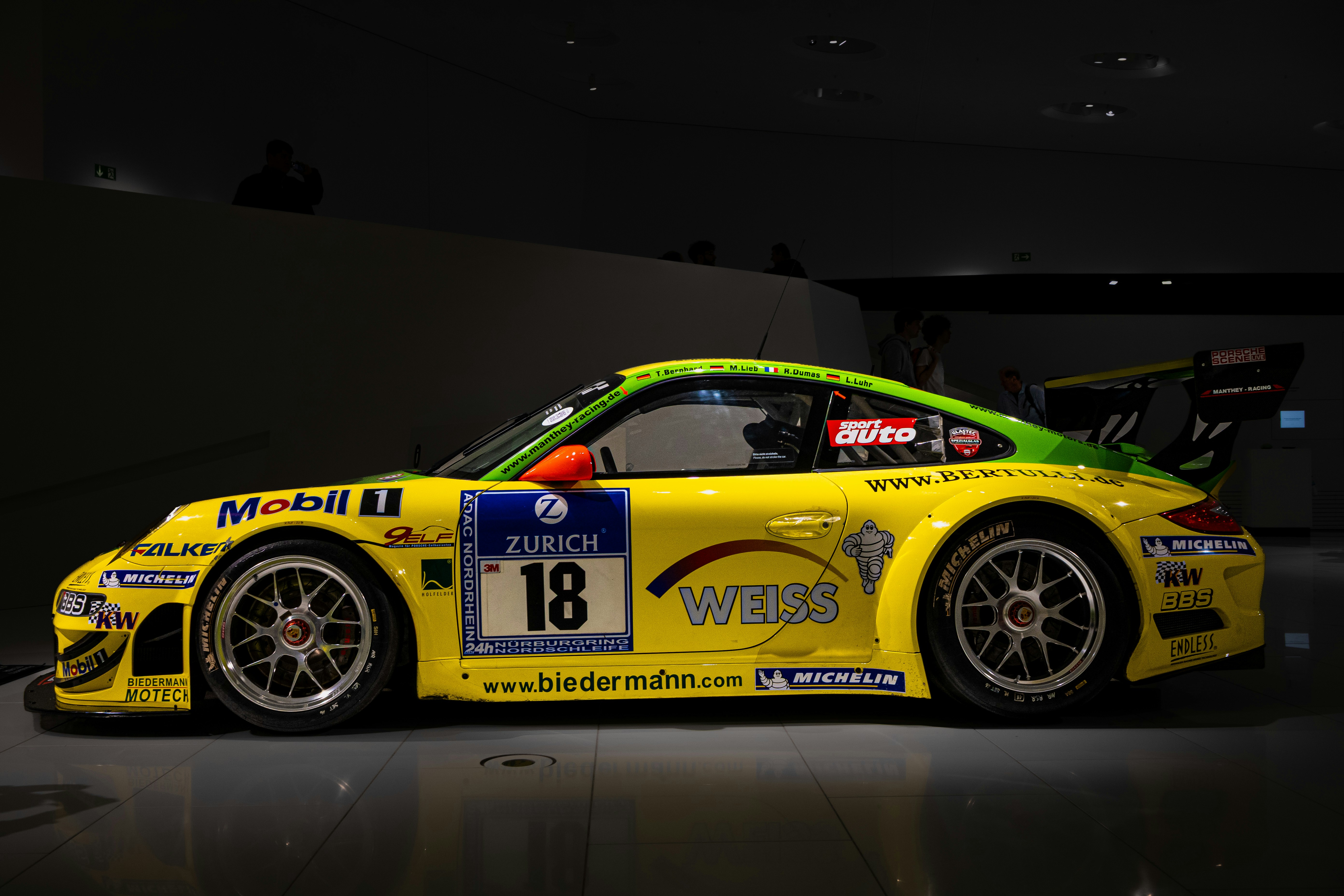 Yellow race machine in a low-lit showroom bloom