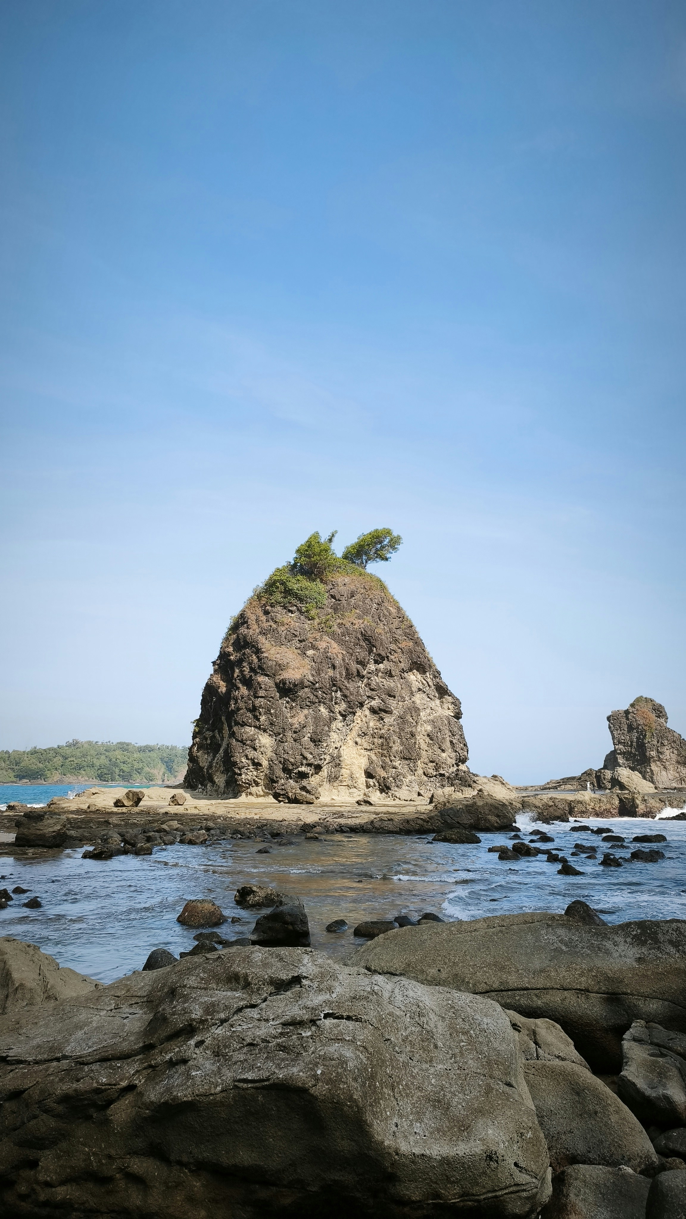 Isolated Sea Stack Rising Above Tidal Shallows