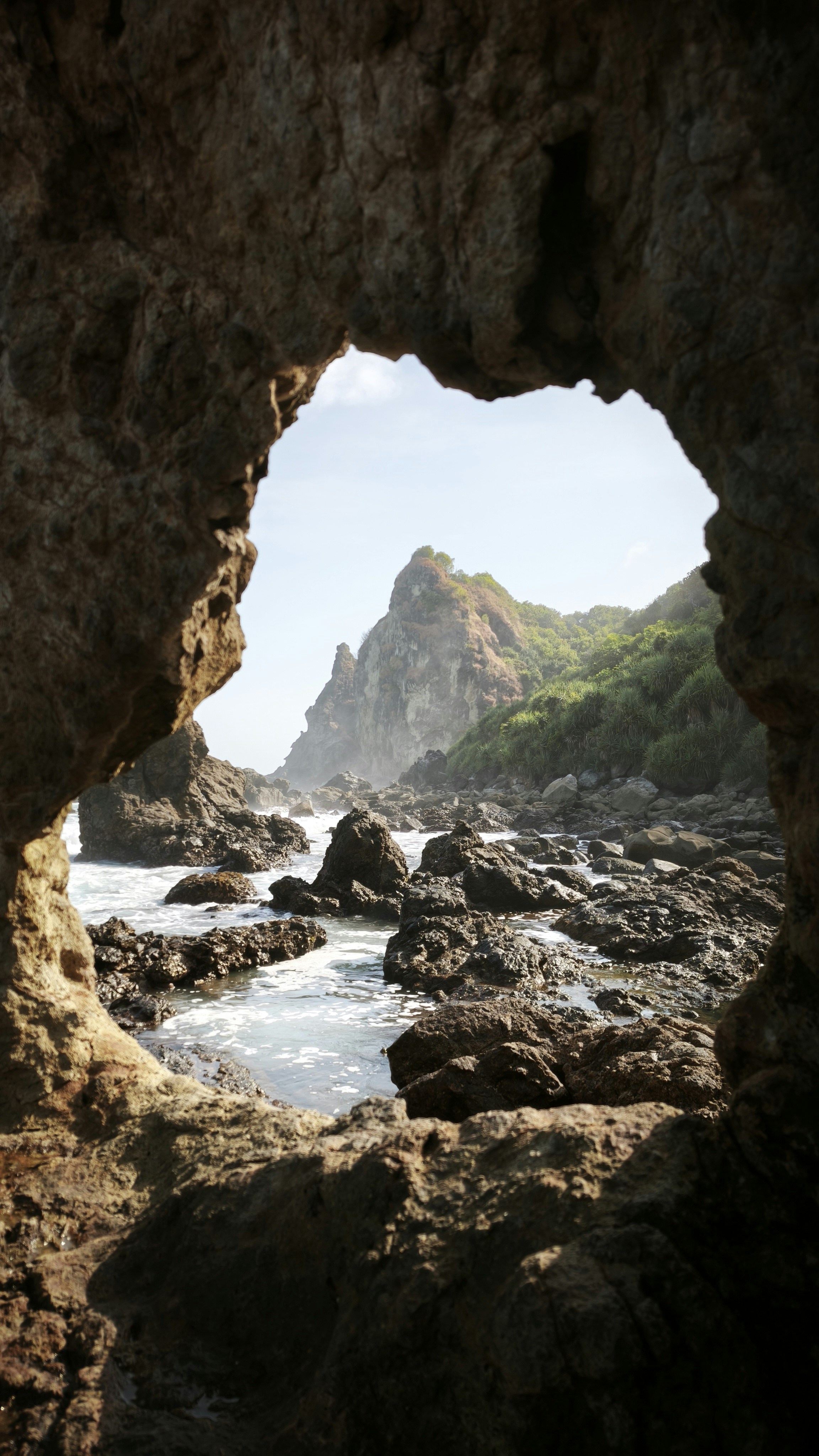 View Through a Sea-Temple Window: Cliffside Arch Framed by Ocean Light
