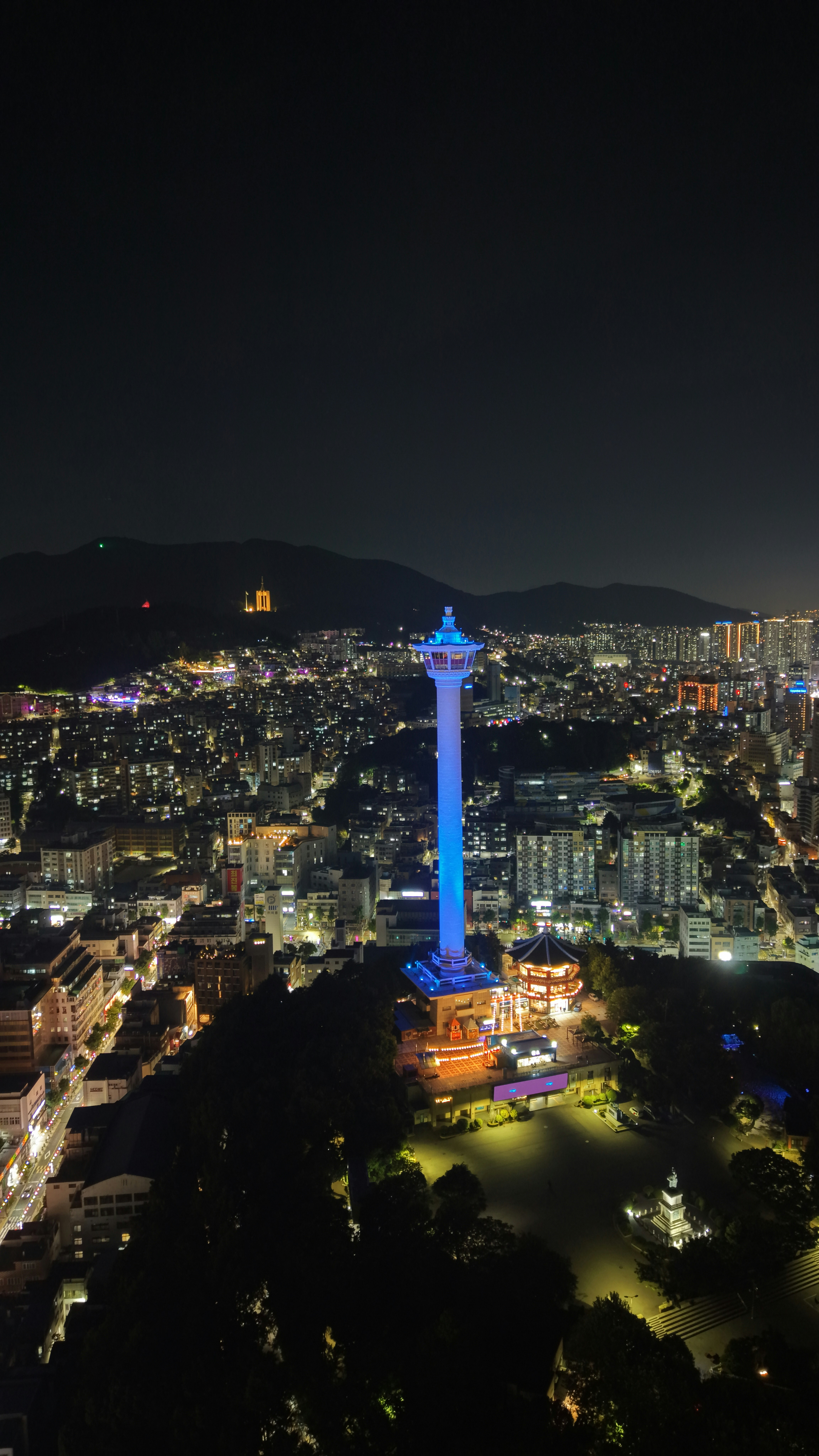 Blue Tower Torch: Nightscape over a Lively City