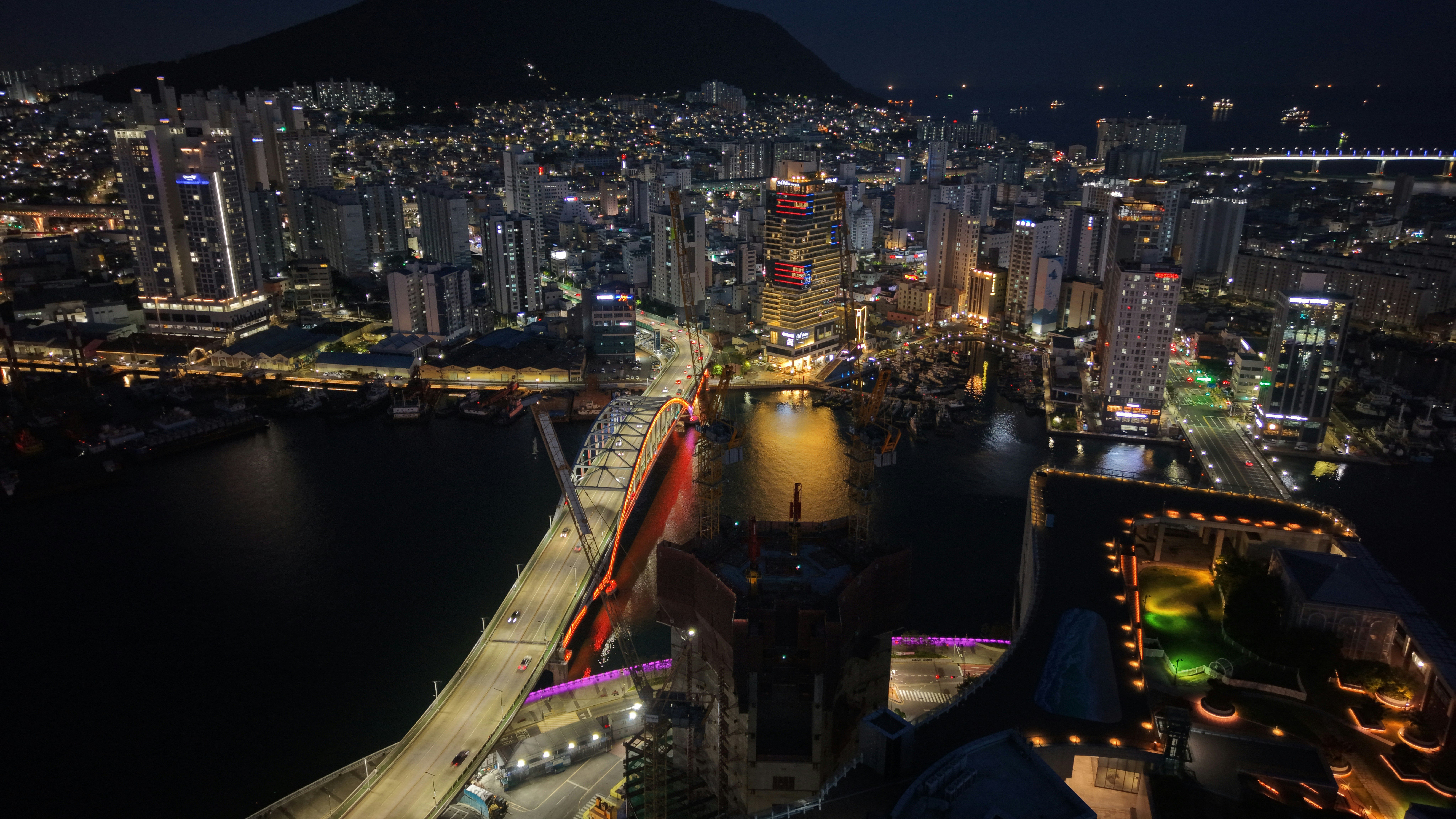 Neon Arches Over the Harbor: A City at Night