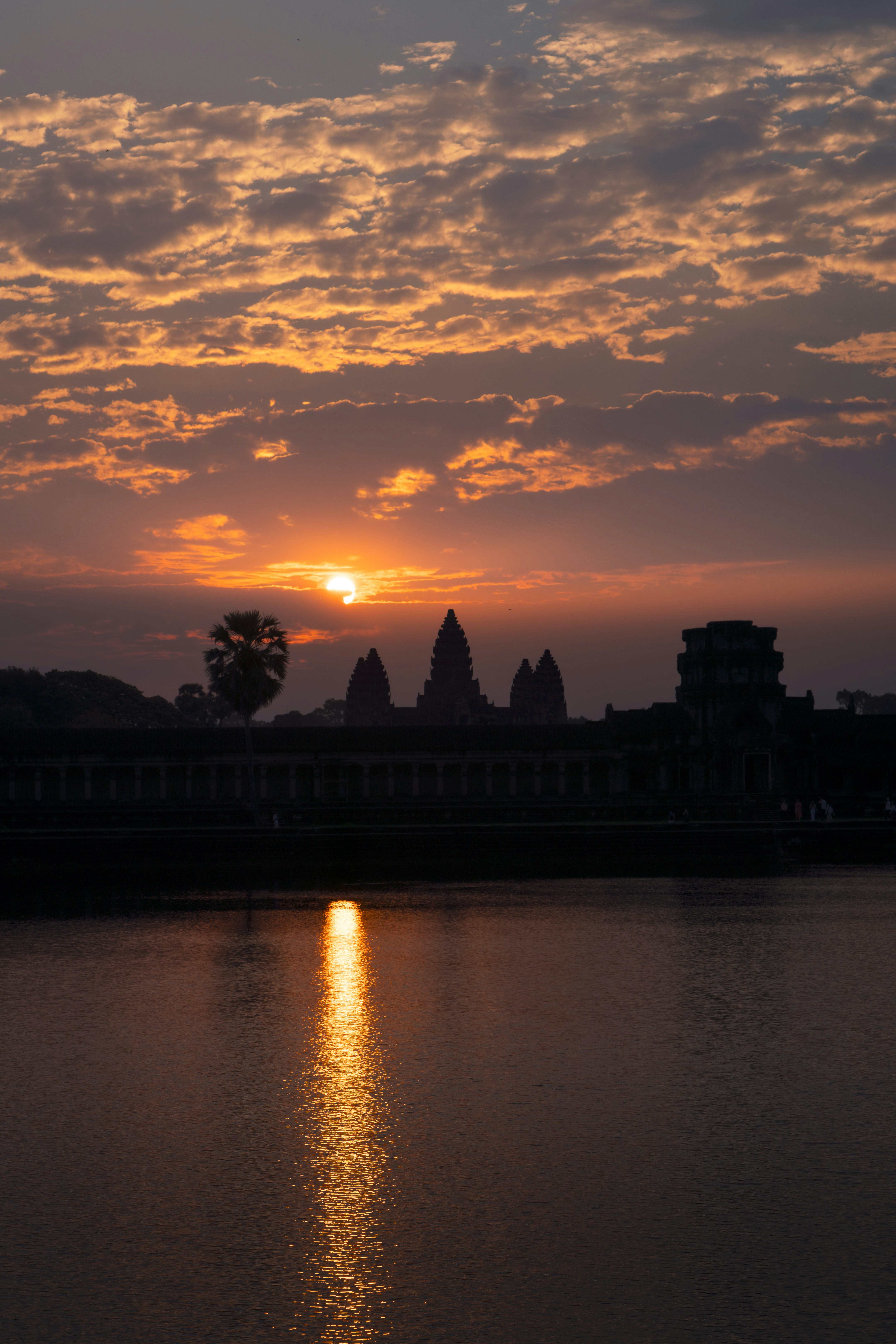 Silhouetted Temples at Dusk Over a Reflective River
