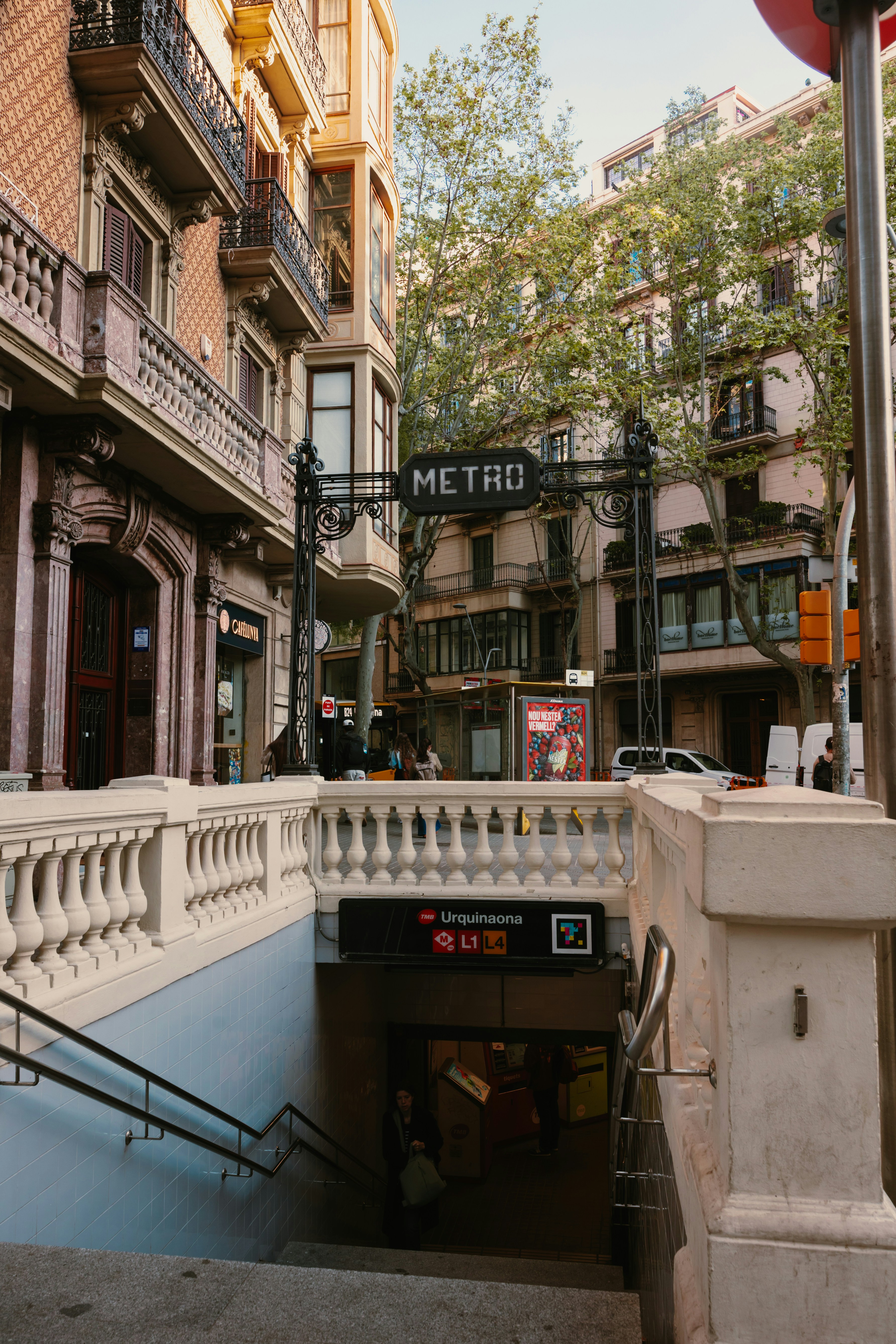 Metro Entrance Overlook: Urban Staircase Beneath a City Gateway Sign