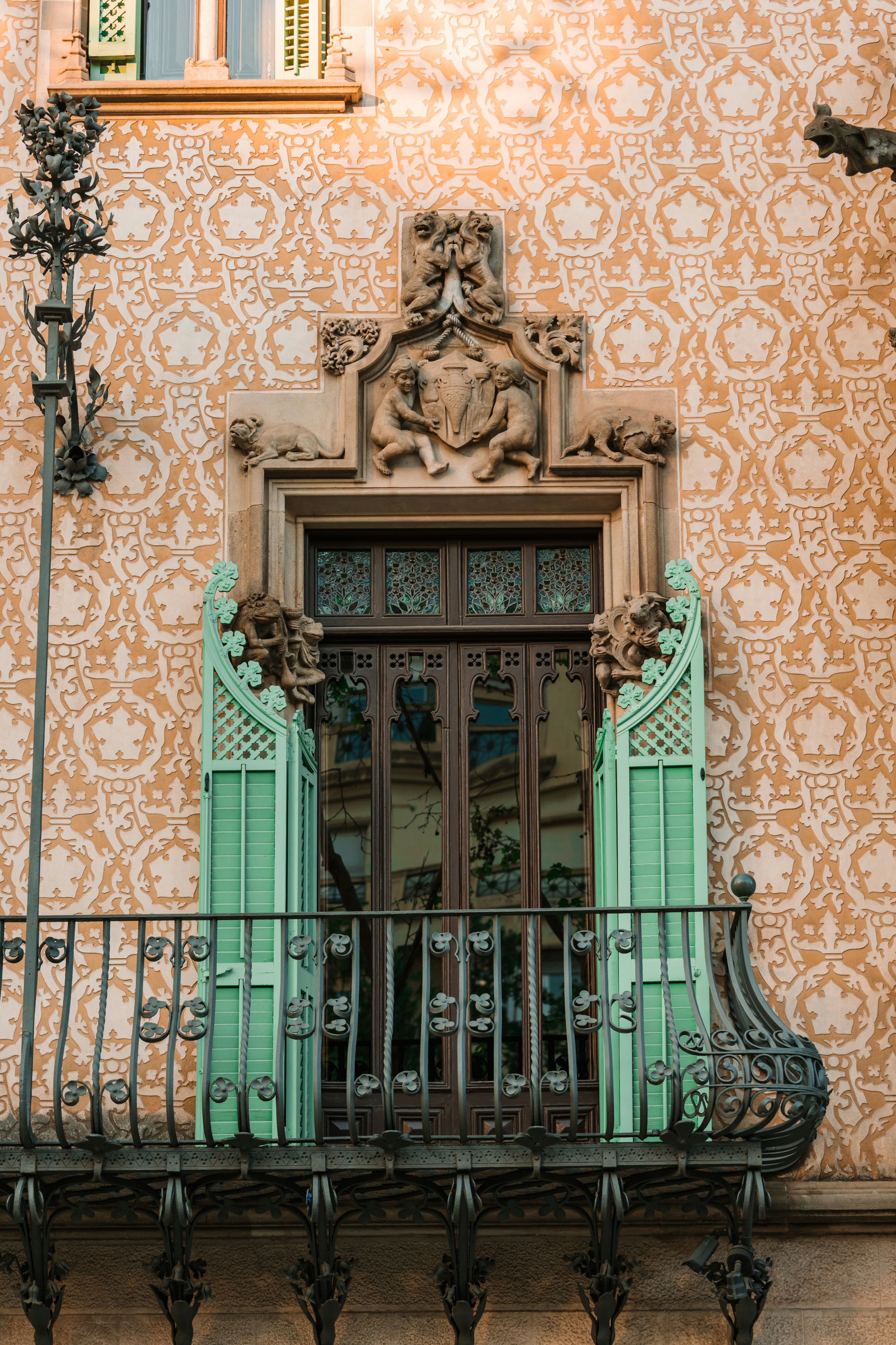 Balcony Baroque: Mint Shutters and Ornate Facade