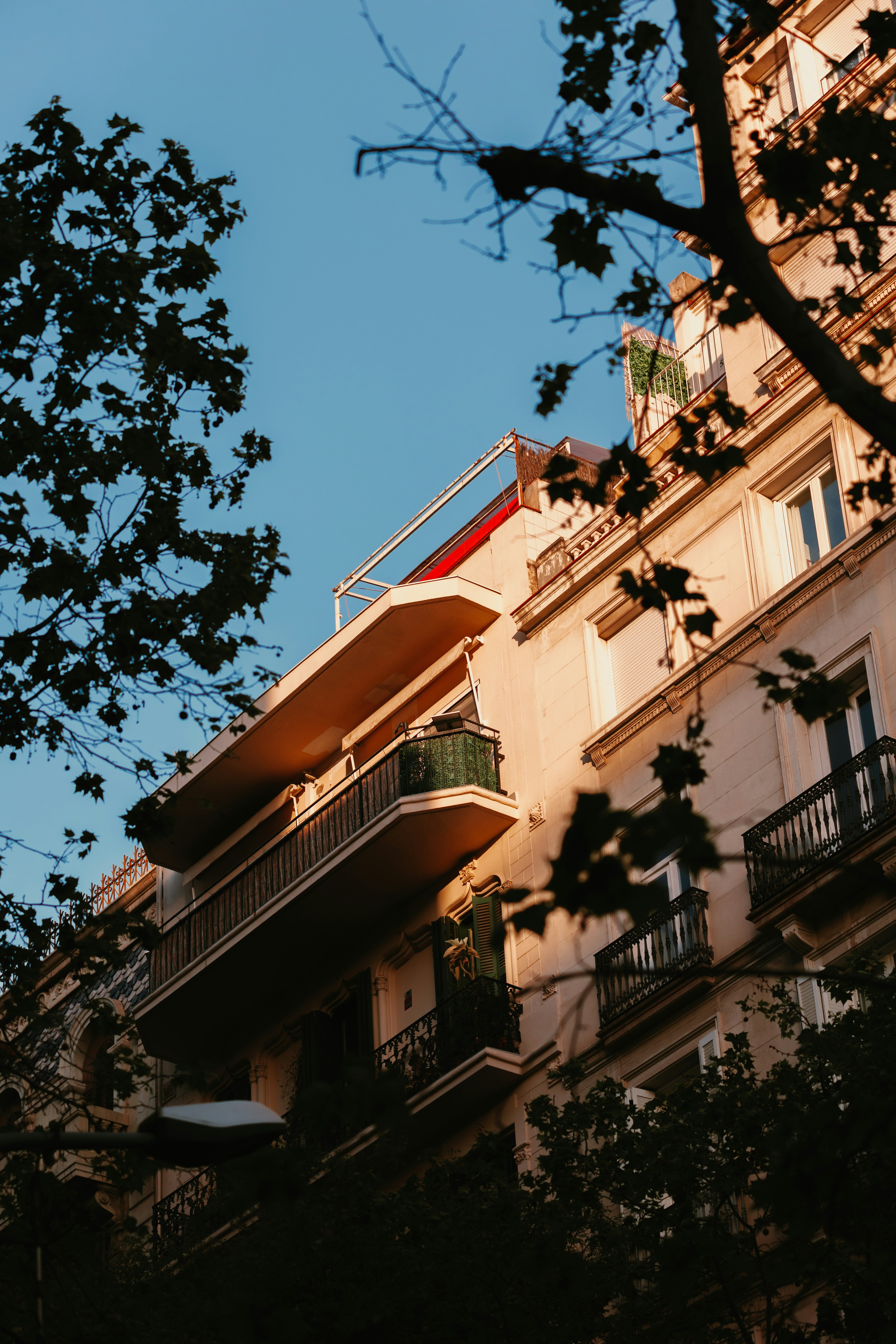 Urban Balcony Stack Reaching Toward a Clear Sky