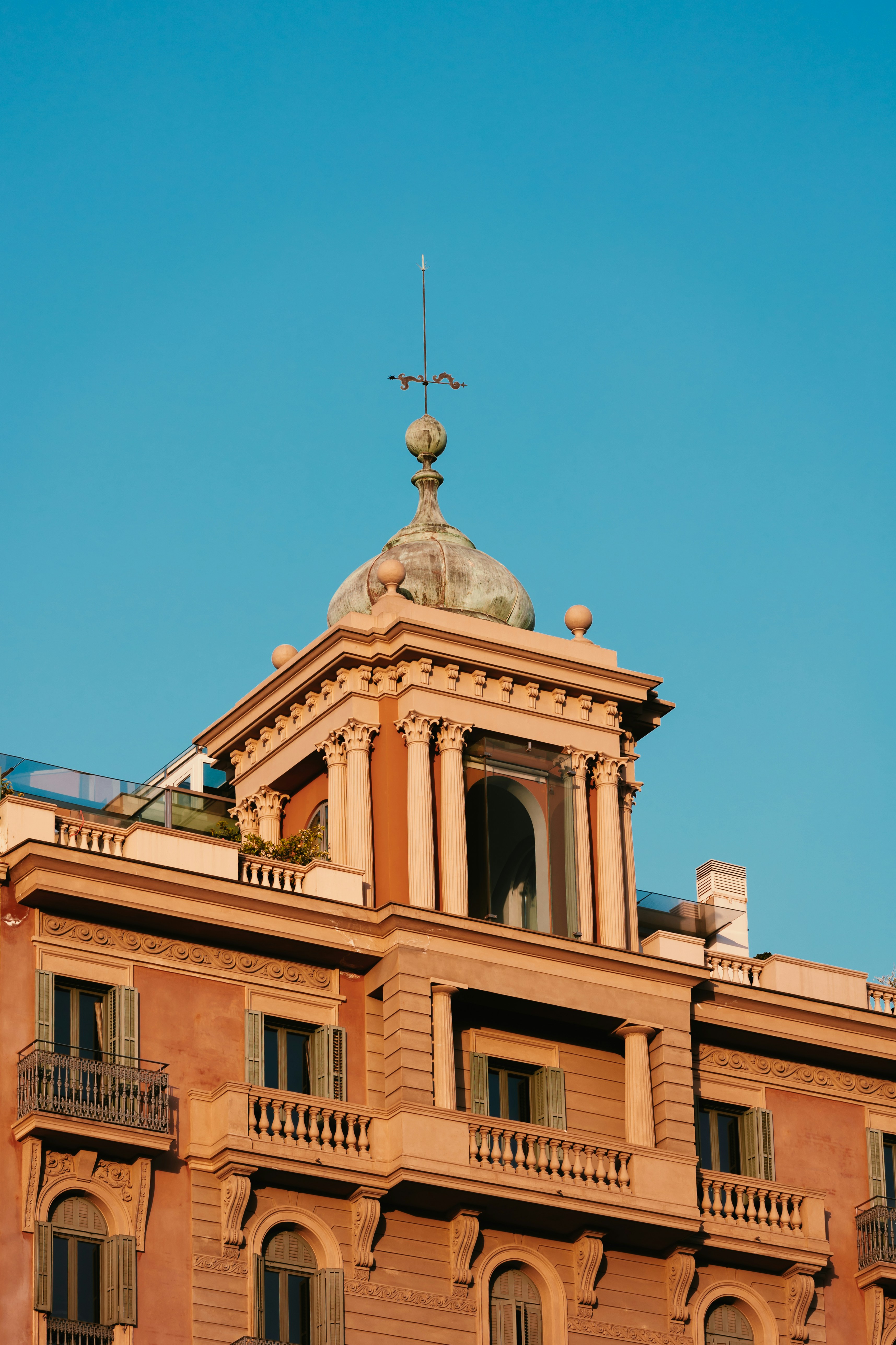 Terracotta Facade Reaching Toward a Clear Sky