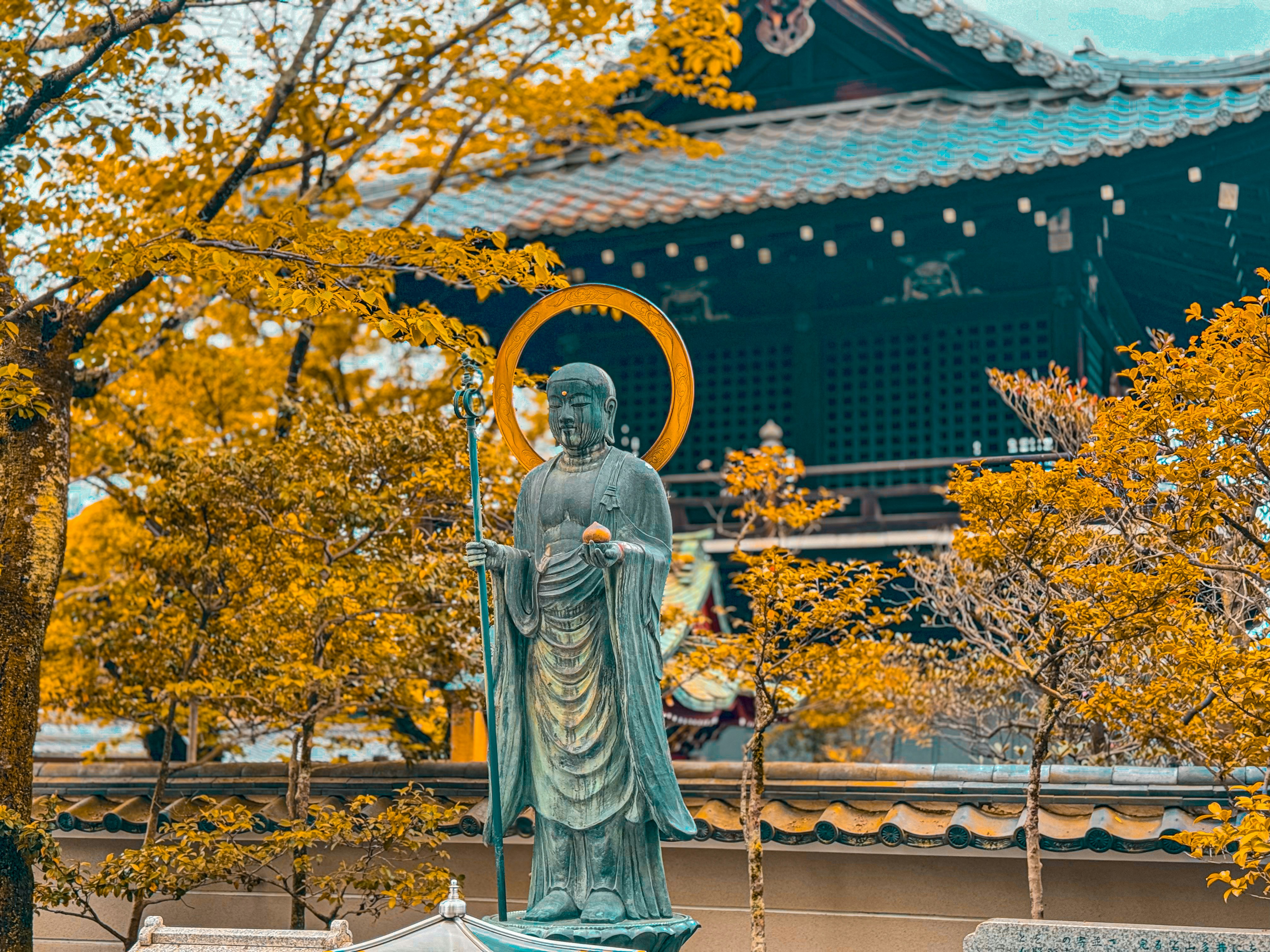 Haloed Guardian: A Bodhisattva Stands Against Autumns in an Orchard of Temples