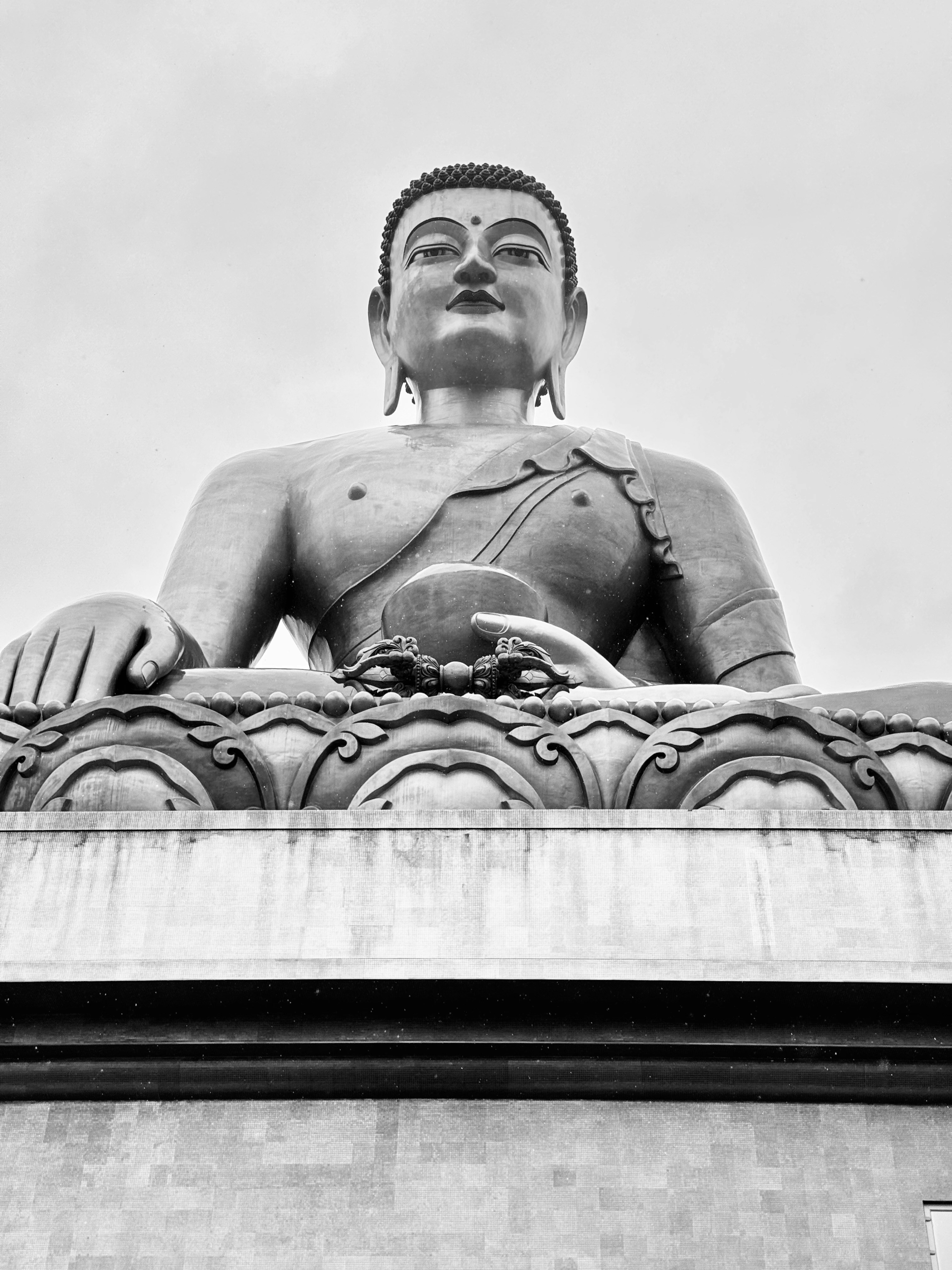 Colossal Serenity: A towering Buddha Overlook on a Concreted Pedestal