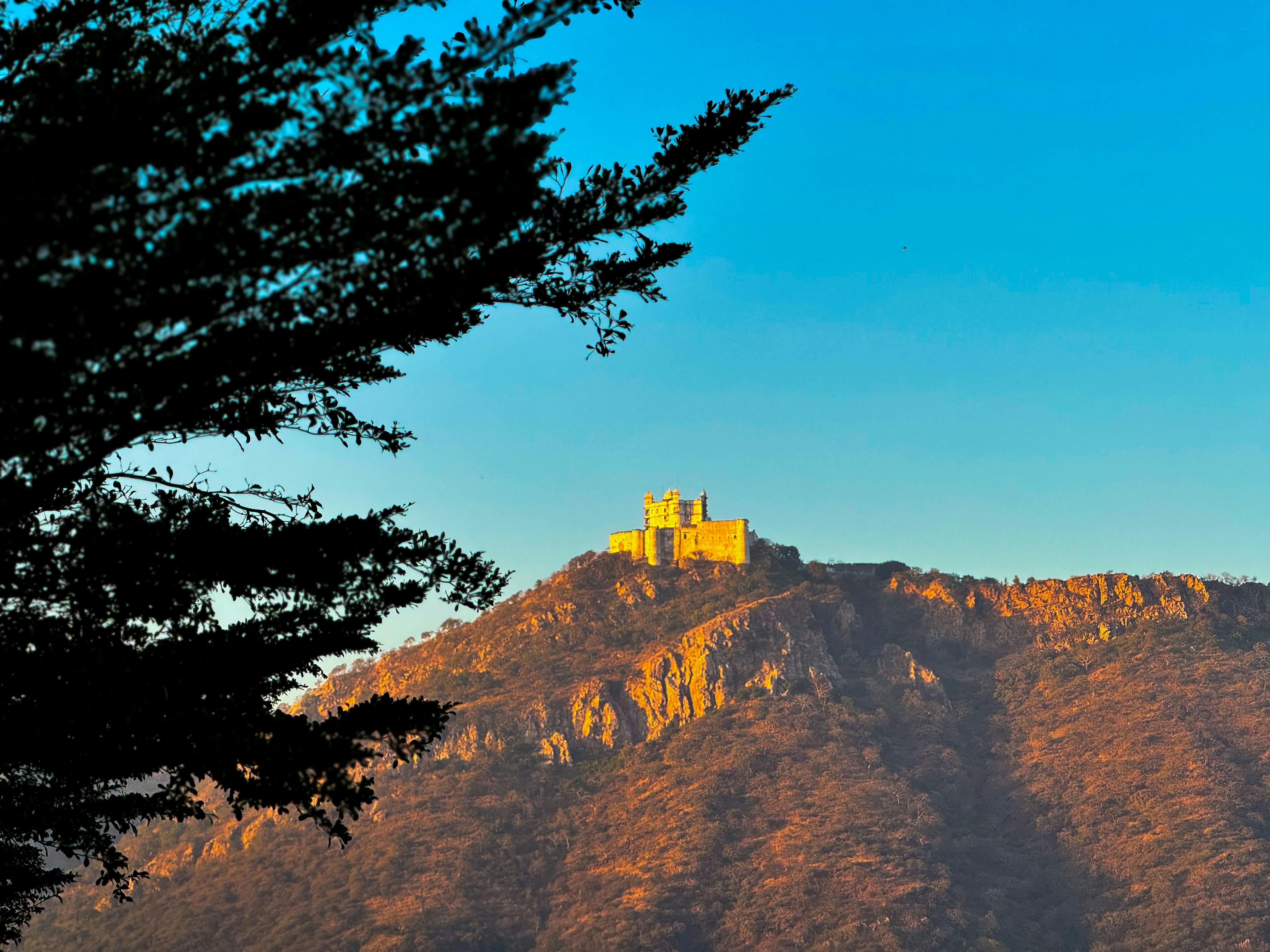 Castle on the Crest: Golden Light over a Silhouetted Ridge