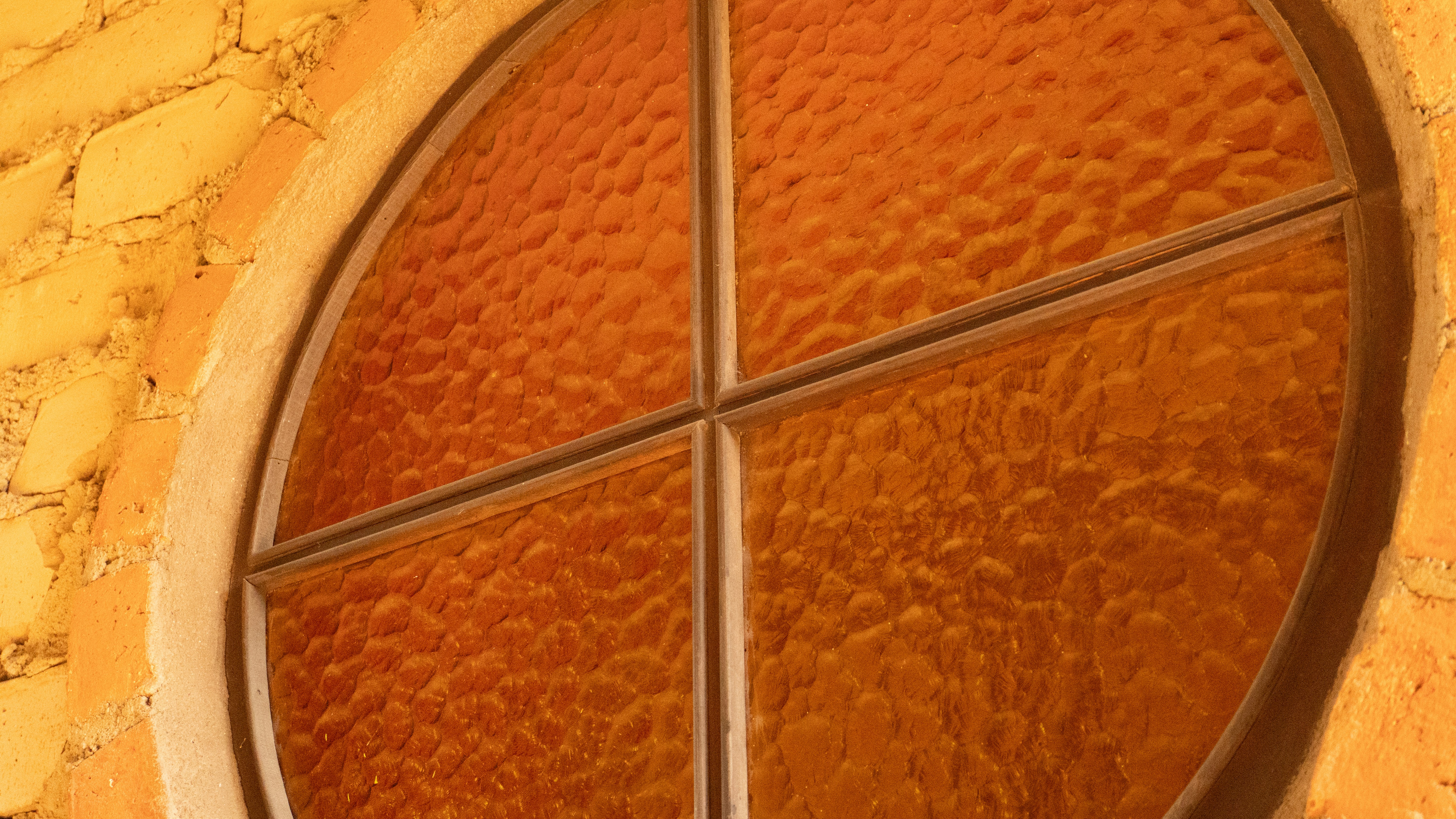 Rust-Colored Archway: A Carved Window into Stone Light