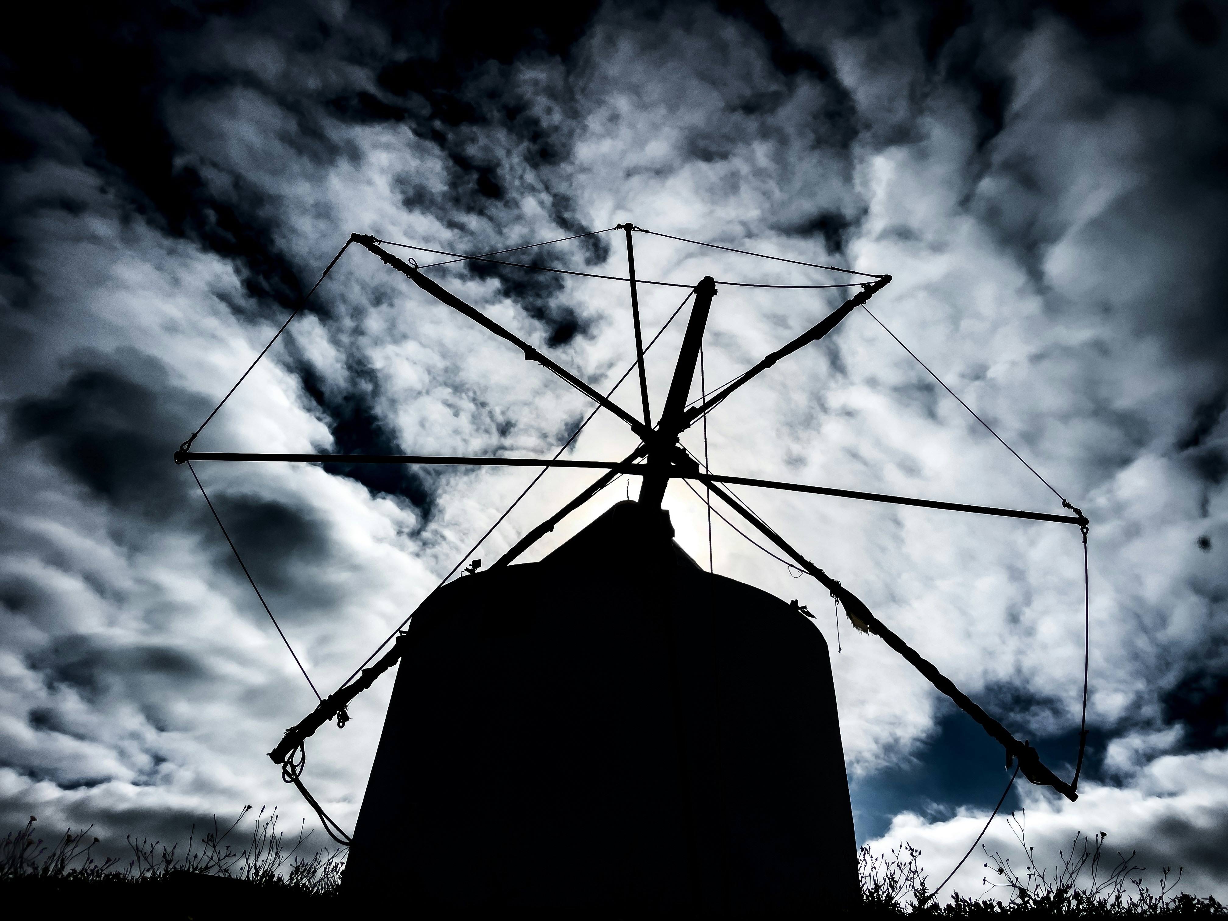Silhouette Antenna Tower against Stormy Sky