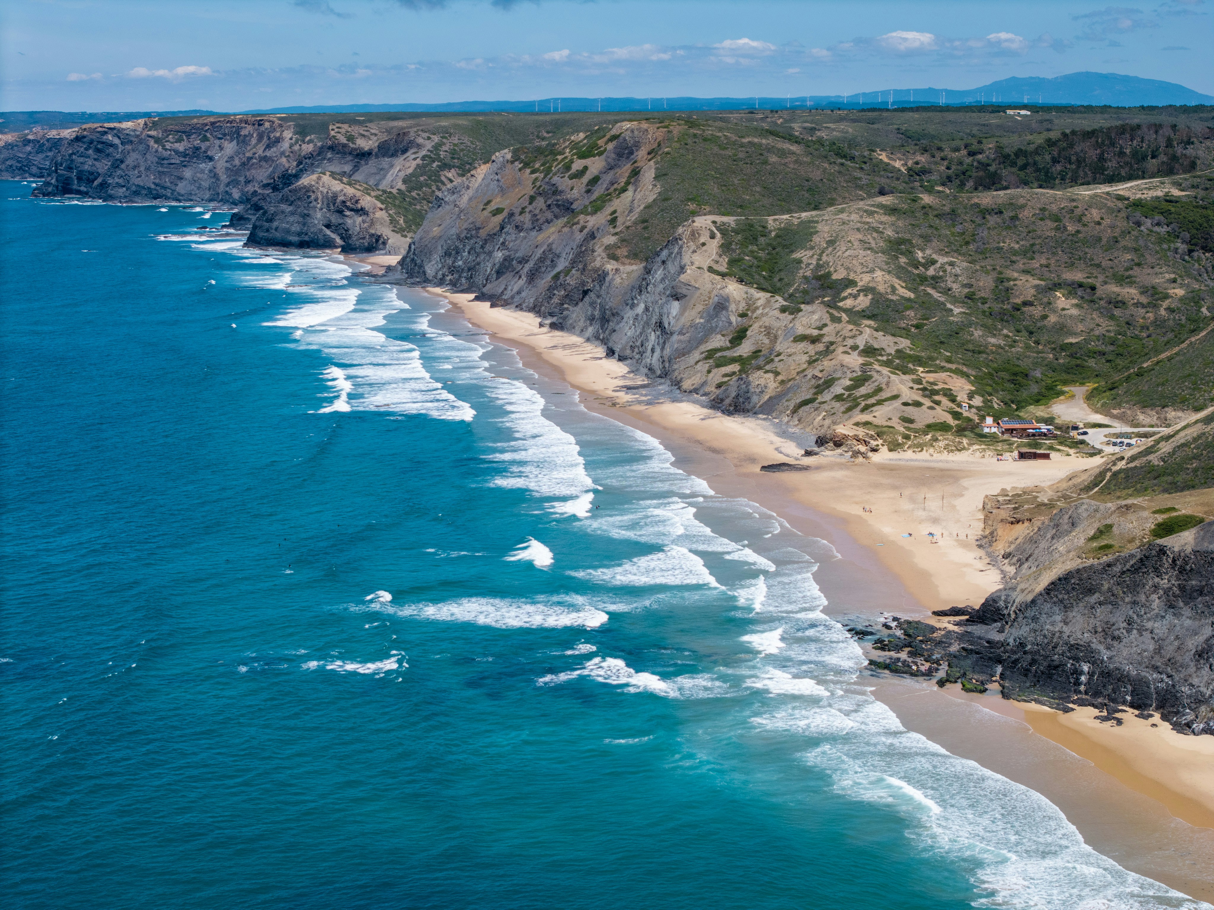 Coastline Curtain: Cliffside Beach in sunlight
