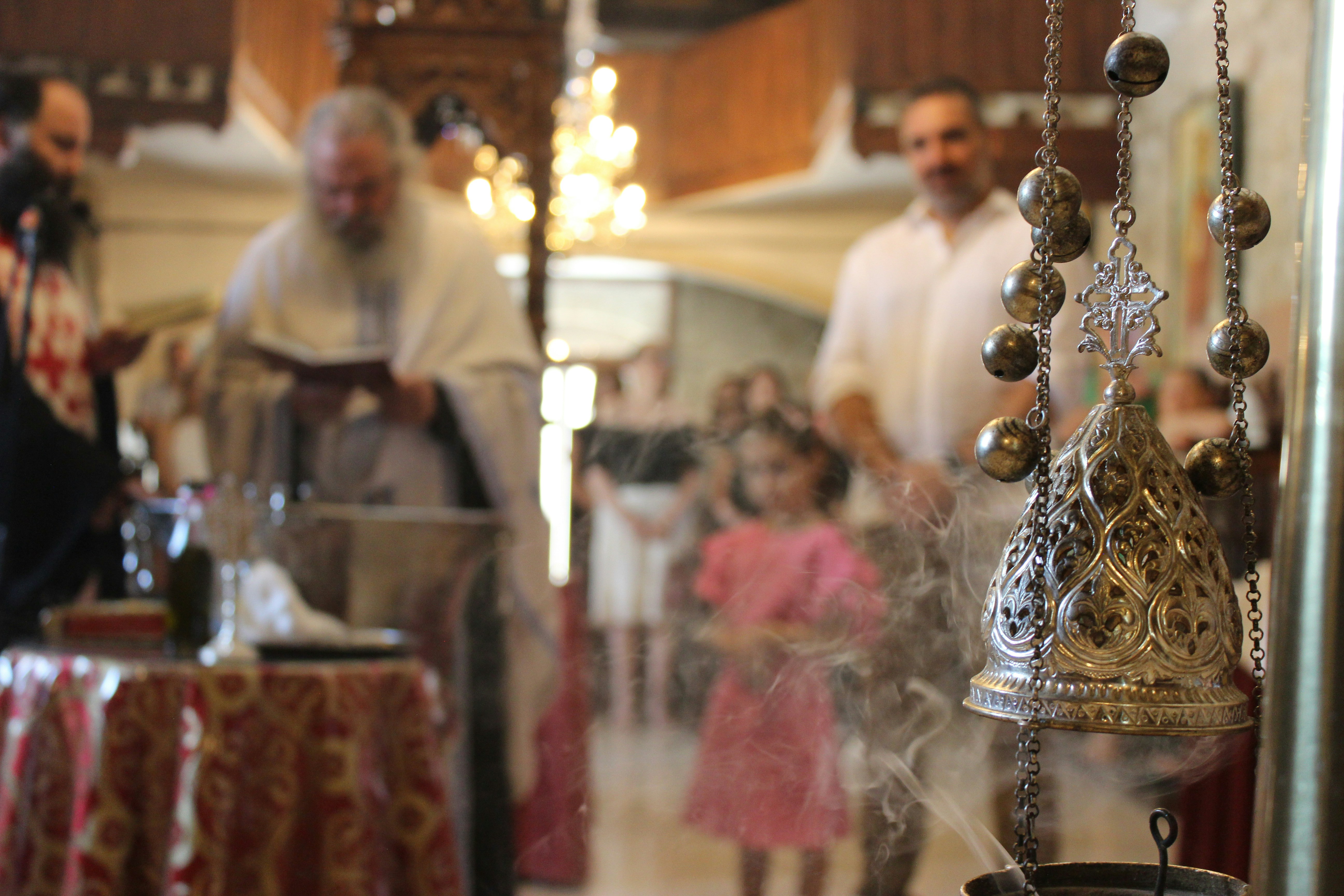 Blessed Silhouette: A ceremonial scene through a bell-ornamented veil