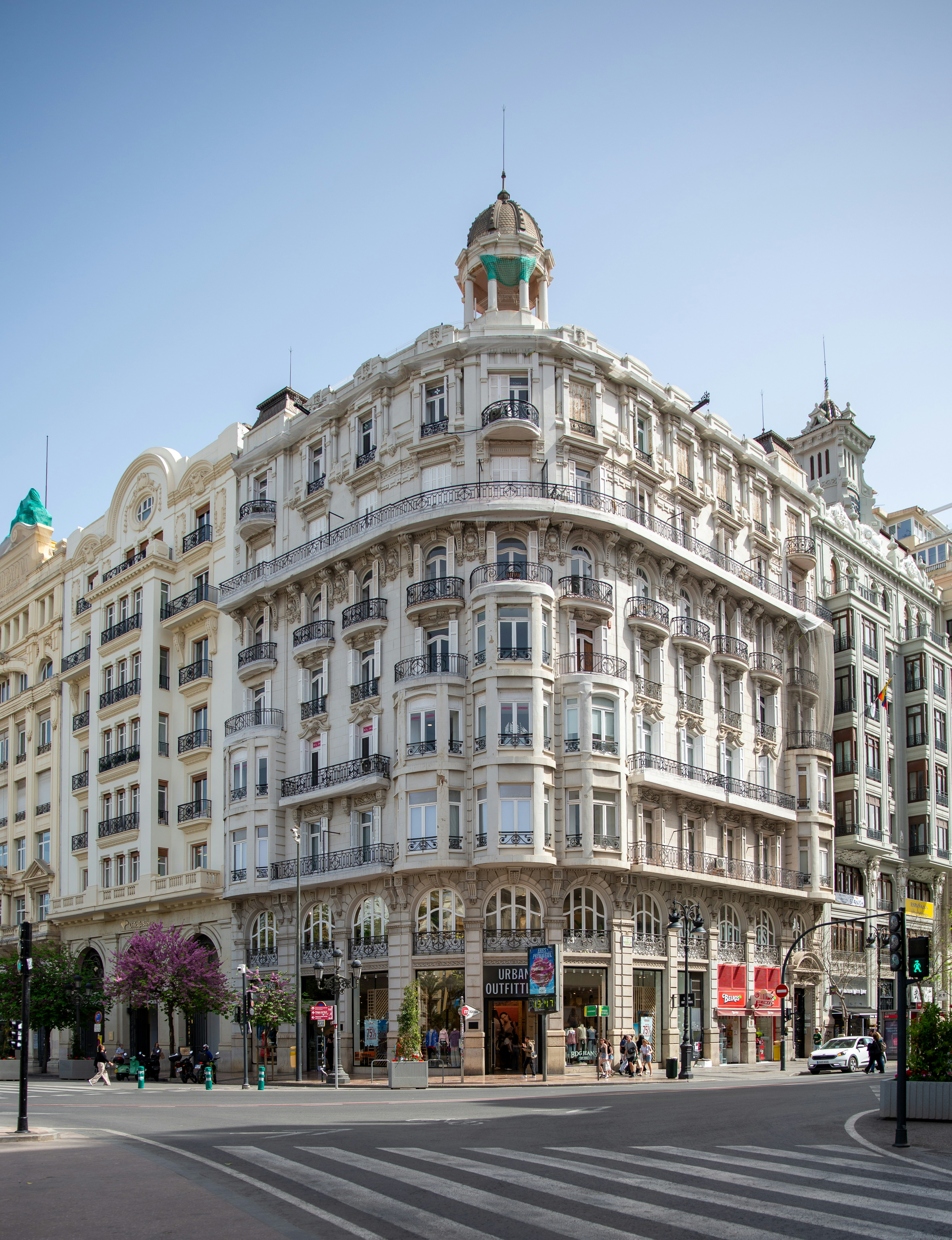 Curved Facade, Corner Café: A Grand Madrid-Style Corner Building on a Busy Street