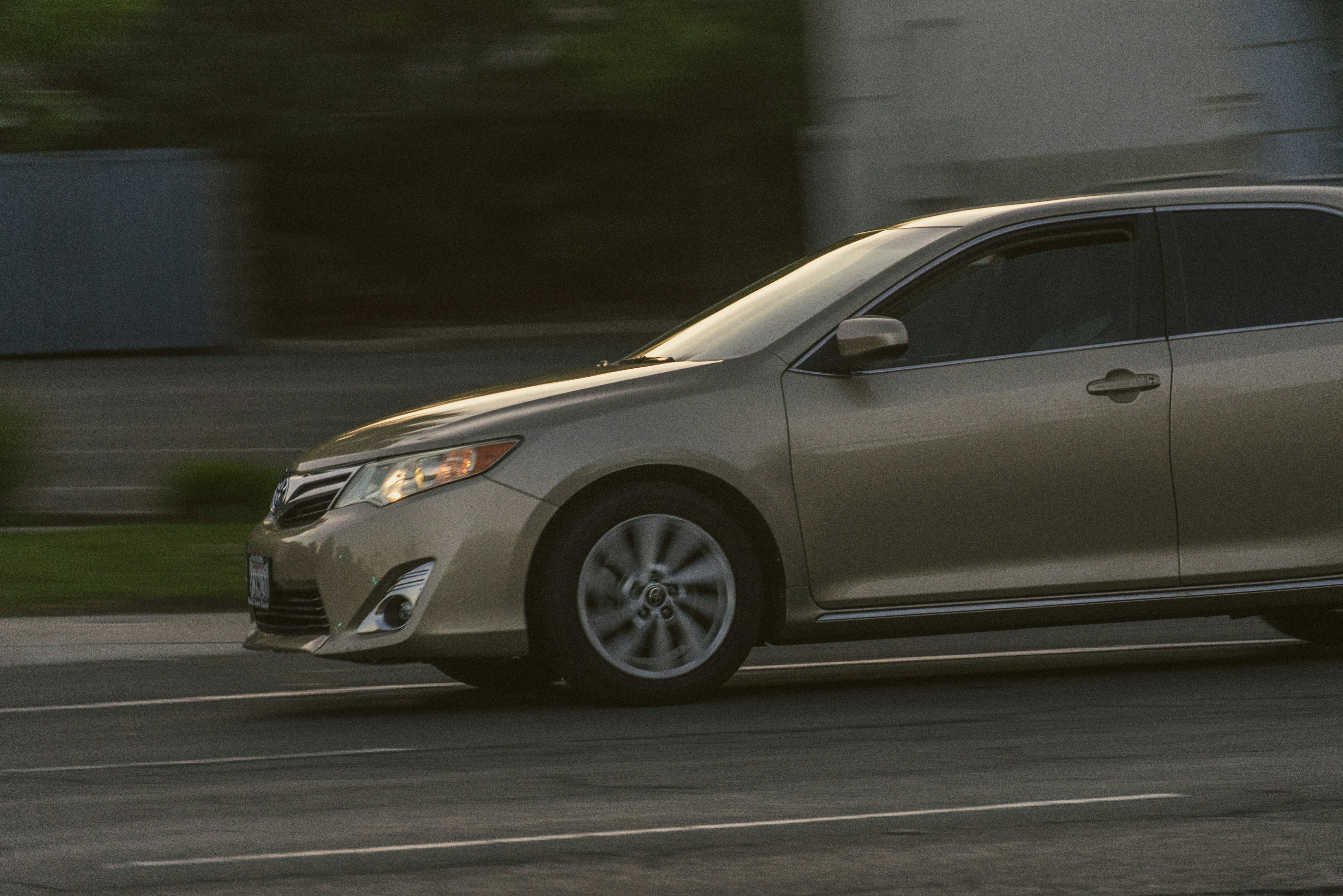 Moving Portrait: mid‑lane sedan in motion