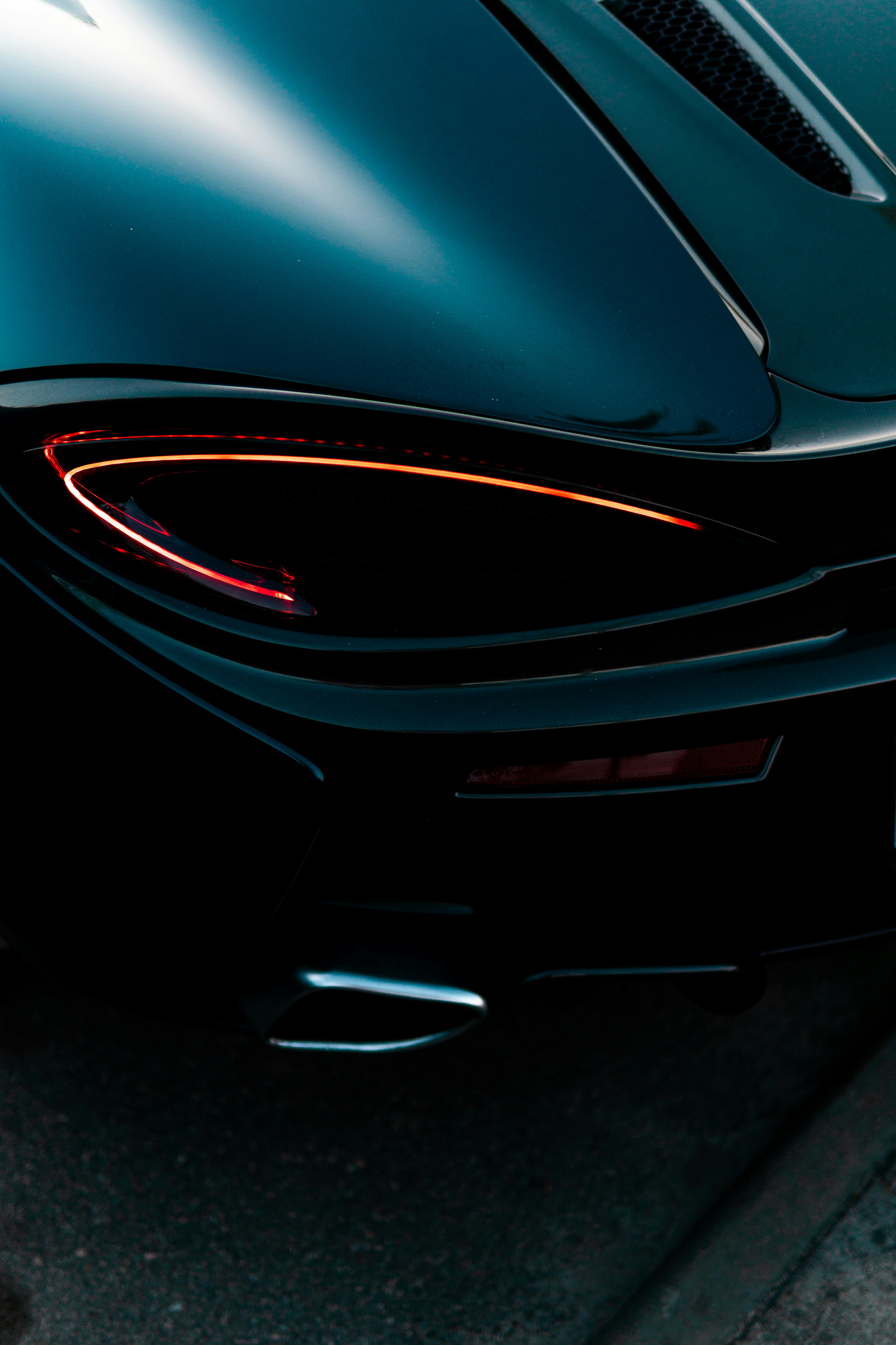 Blue Metallic Car Hood and Sleek Headlight Geometry
