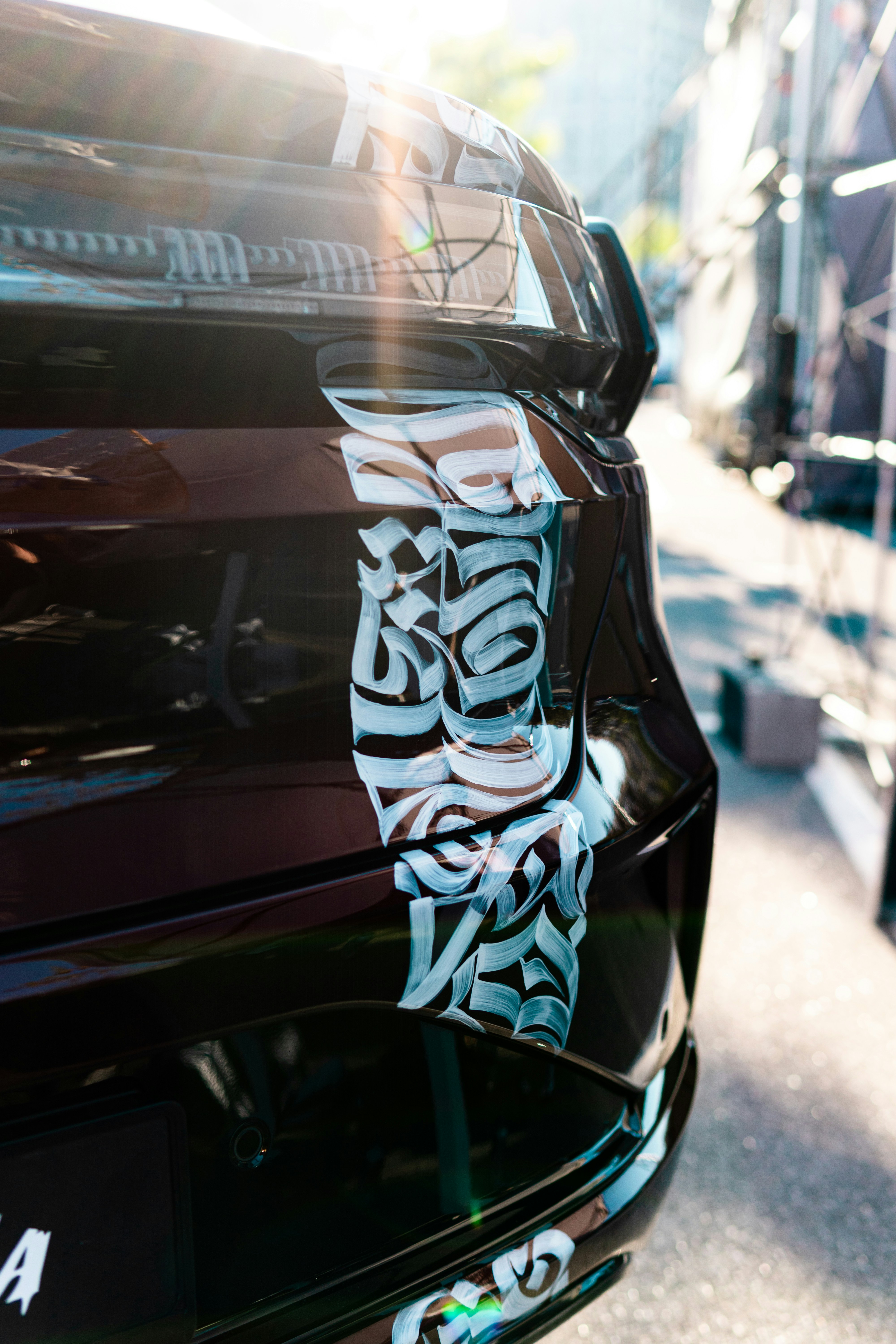 Reflected Skull Murals on a gleaming black car