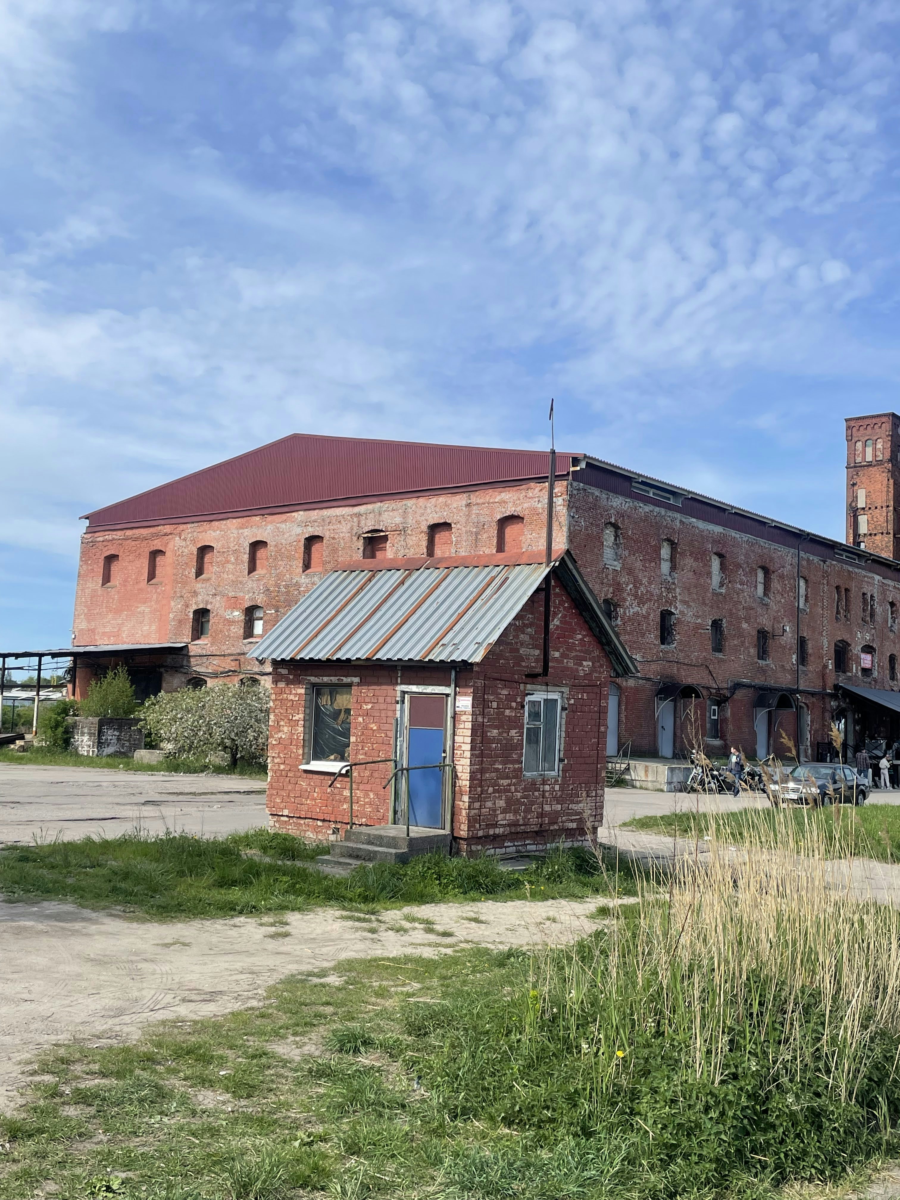 Red Brick Factory at Dusk: A Weathered Outbuilding and Tower