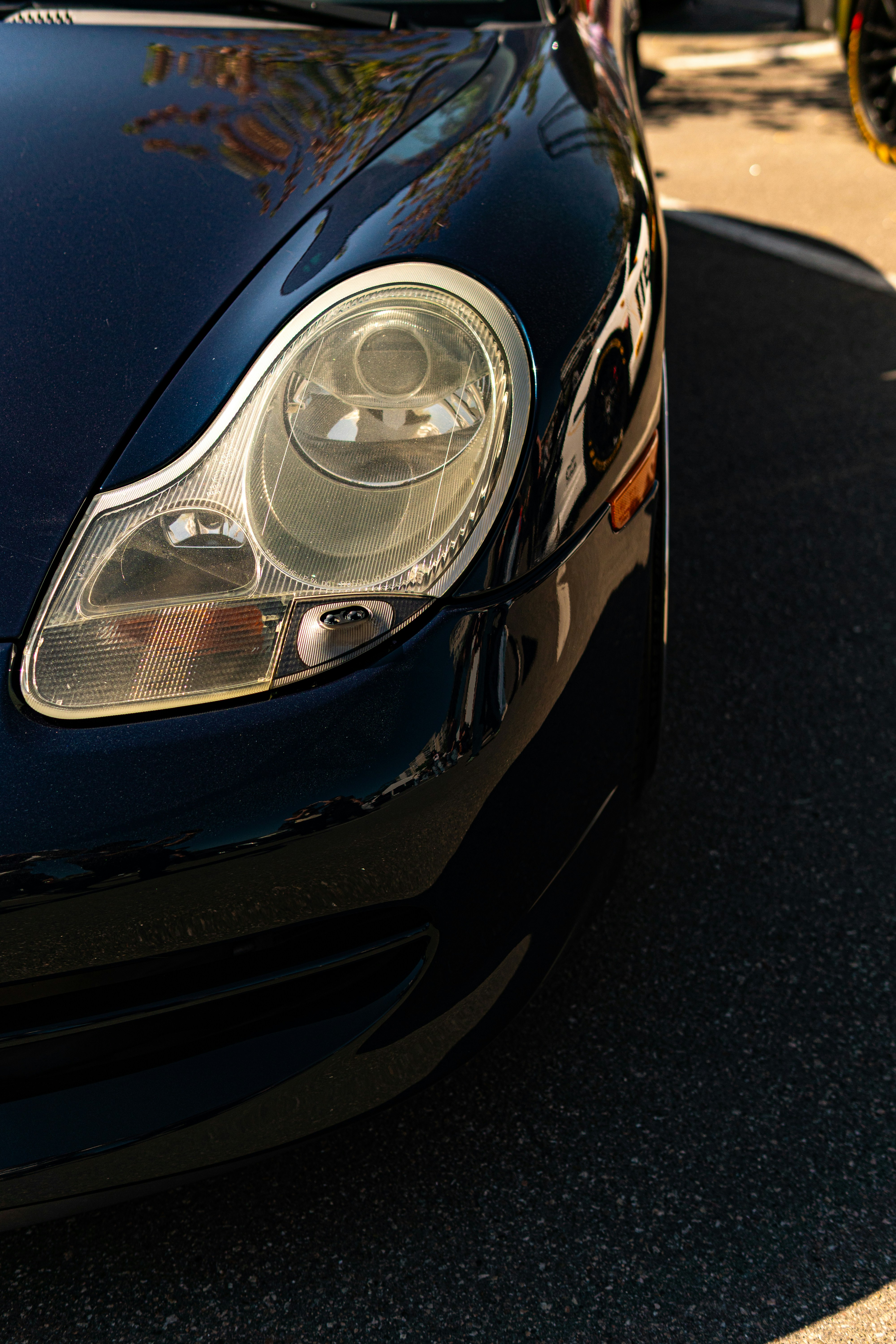 Front-Quarter of a Midnight Porsche: A Glint of Curves and Reflection