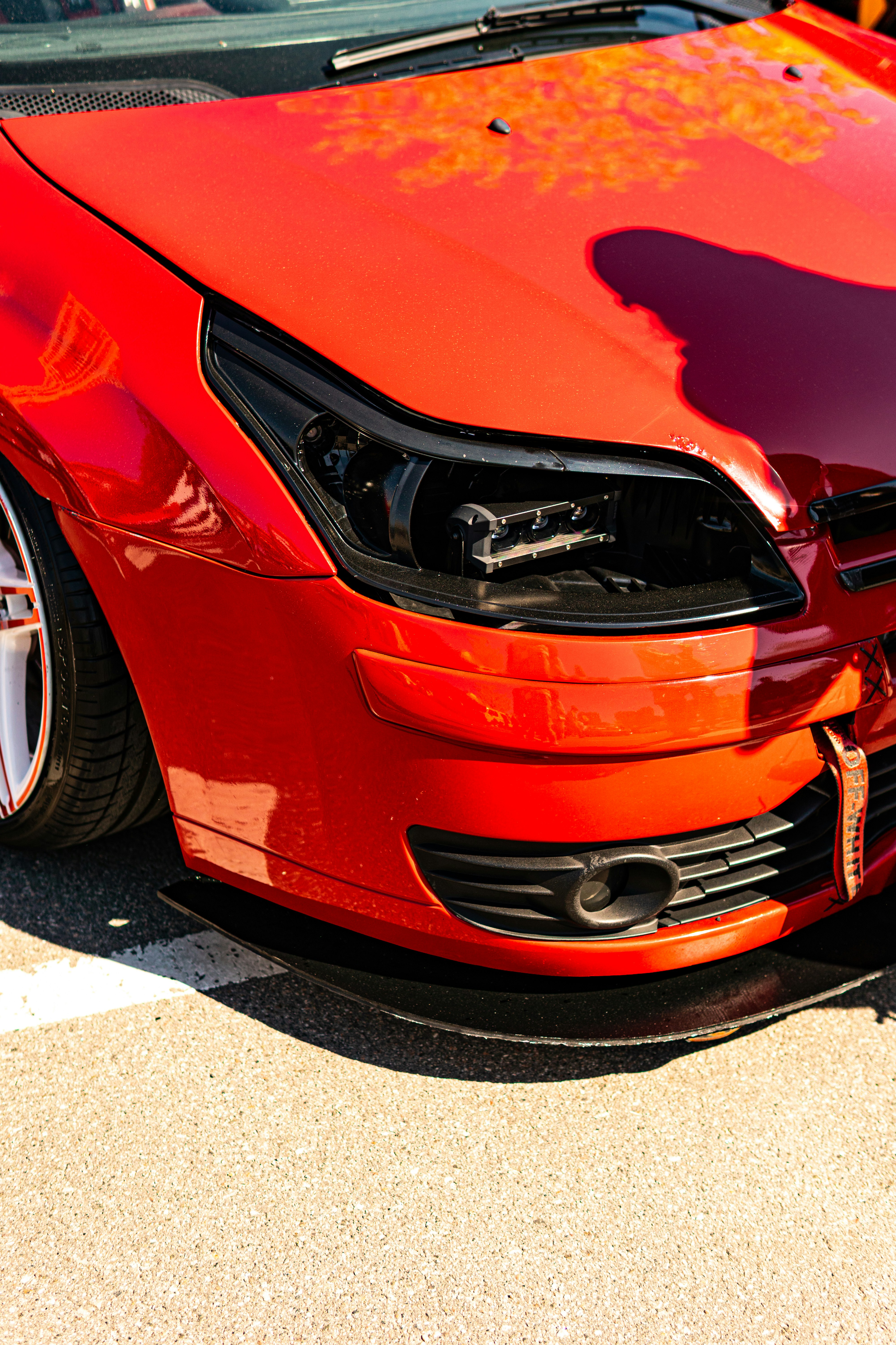 Crimson Hood: A Painted Front Quarter of a Street-Tuned Stallion